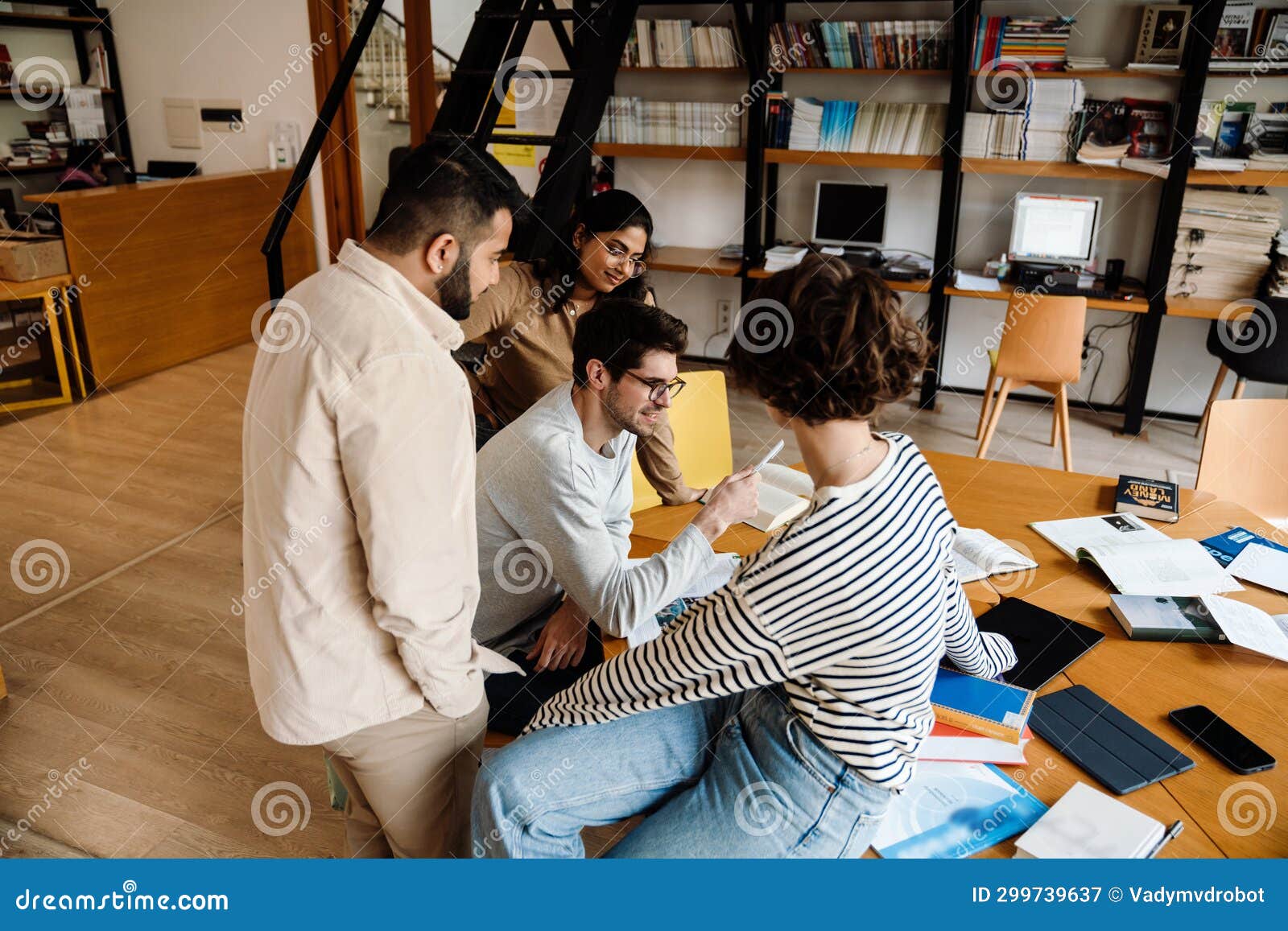 Group of Students Having Discussion while Studying in College Library ...