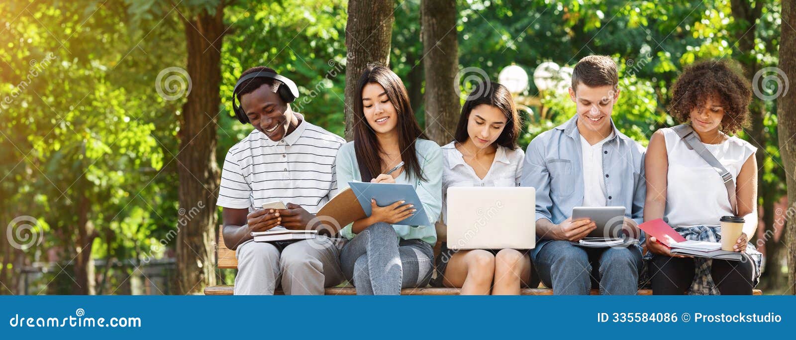 Group of Students with Laptop and Tablet Computer Studying Together ...