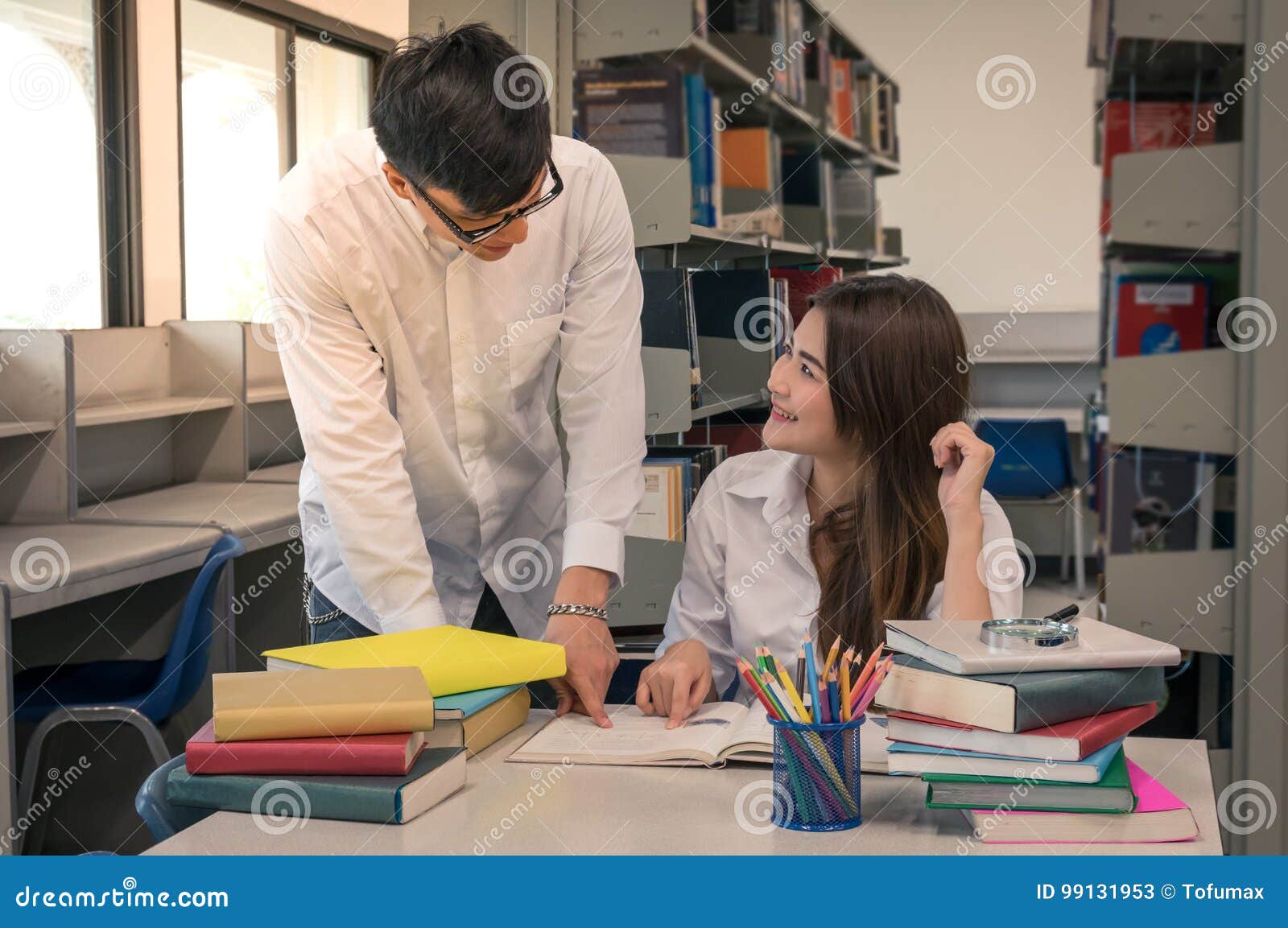 Students leading book stock image. Image of young, friends - 99131953