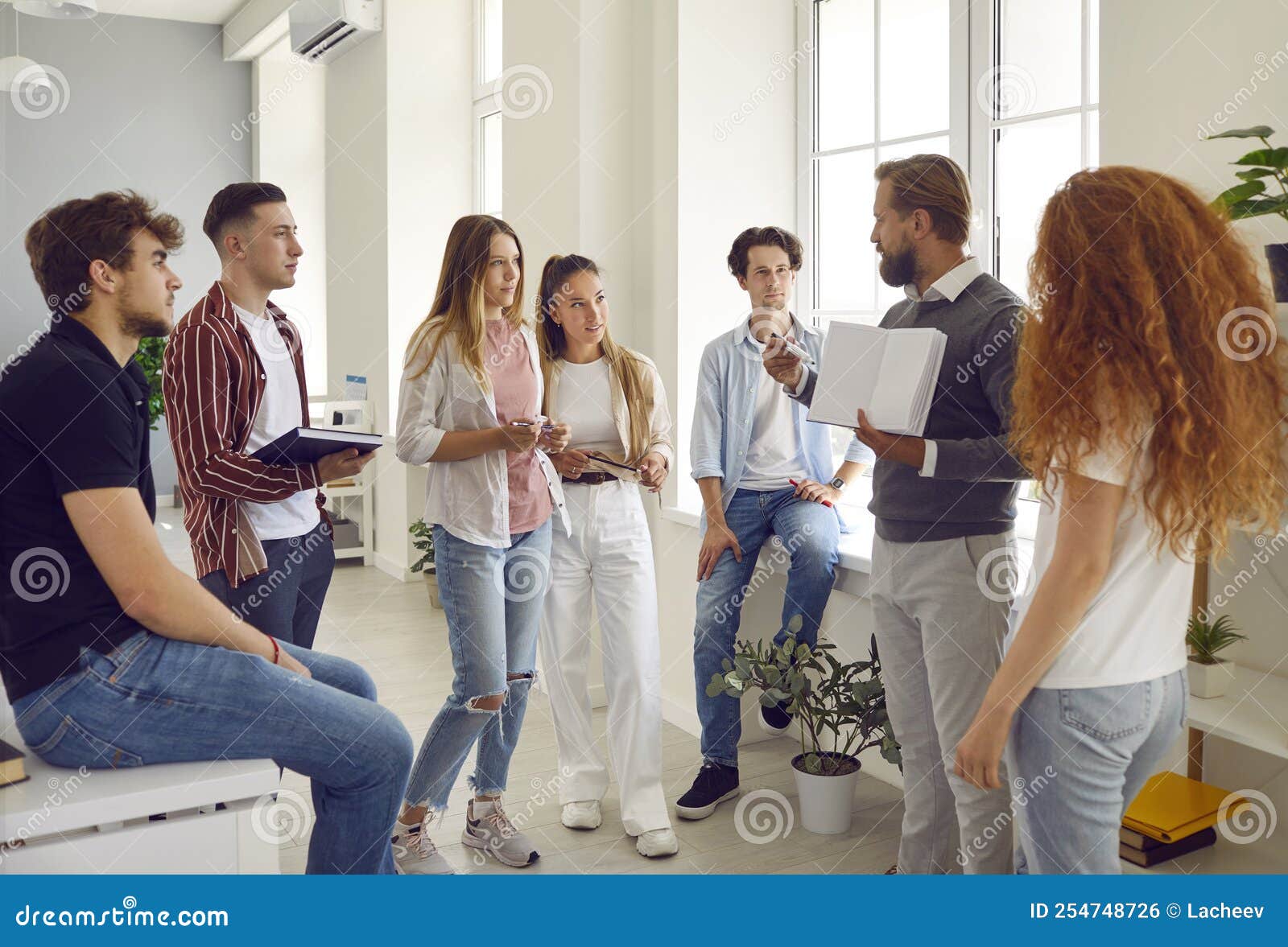 Group of Students Listening a Professor Explaining Something and ...