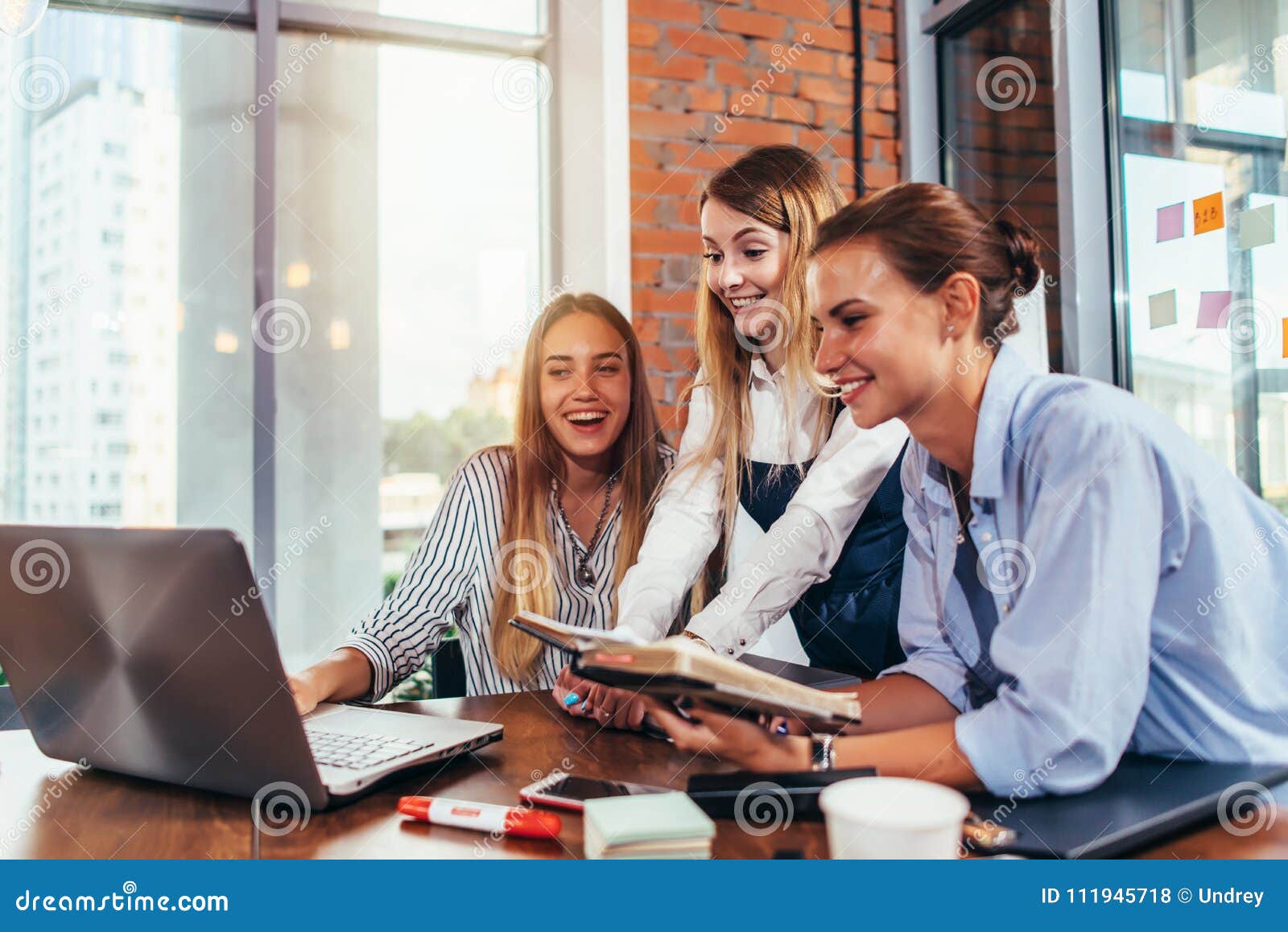 Group of Students Looking at Laptop Taking a Break after Studying in ...