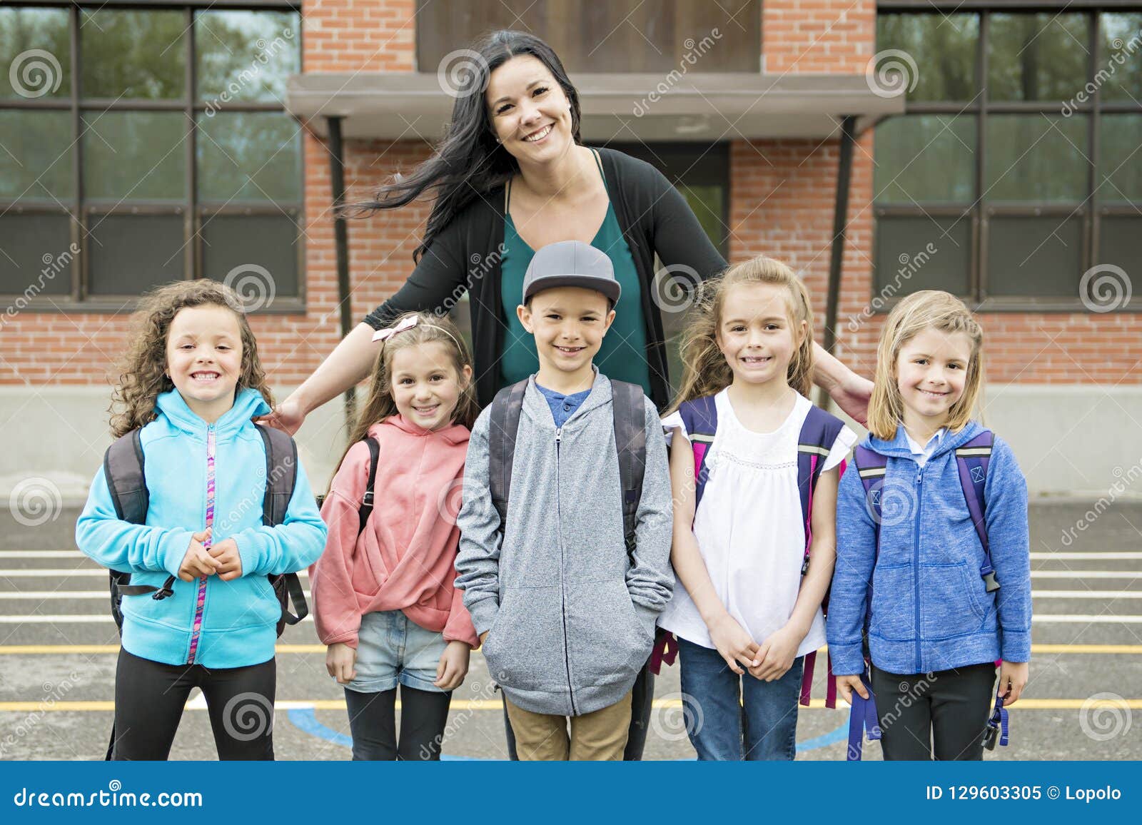 A Group of Students Outside at School Standing Together with Teacher ...