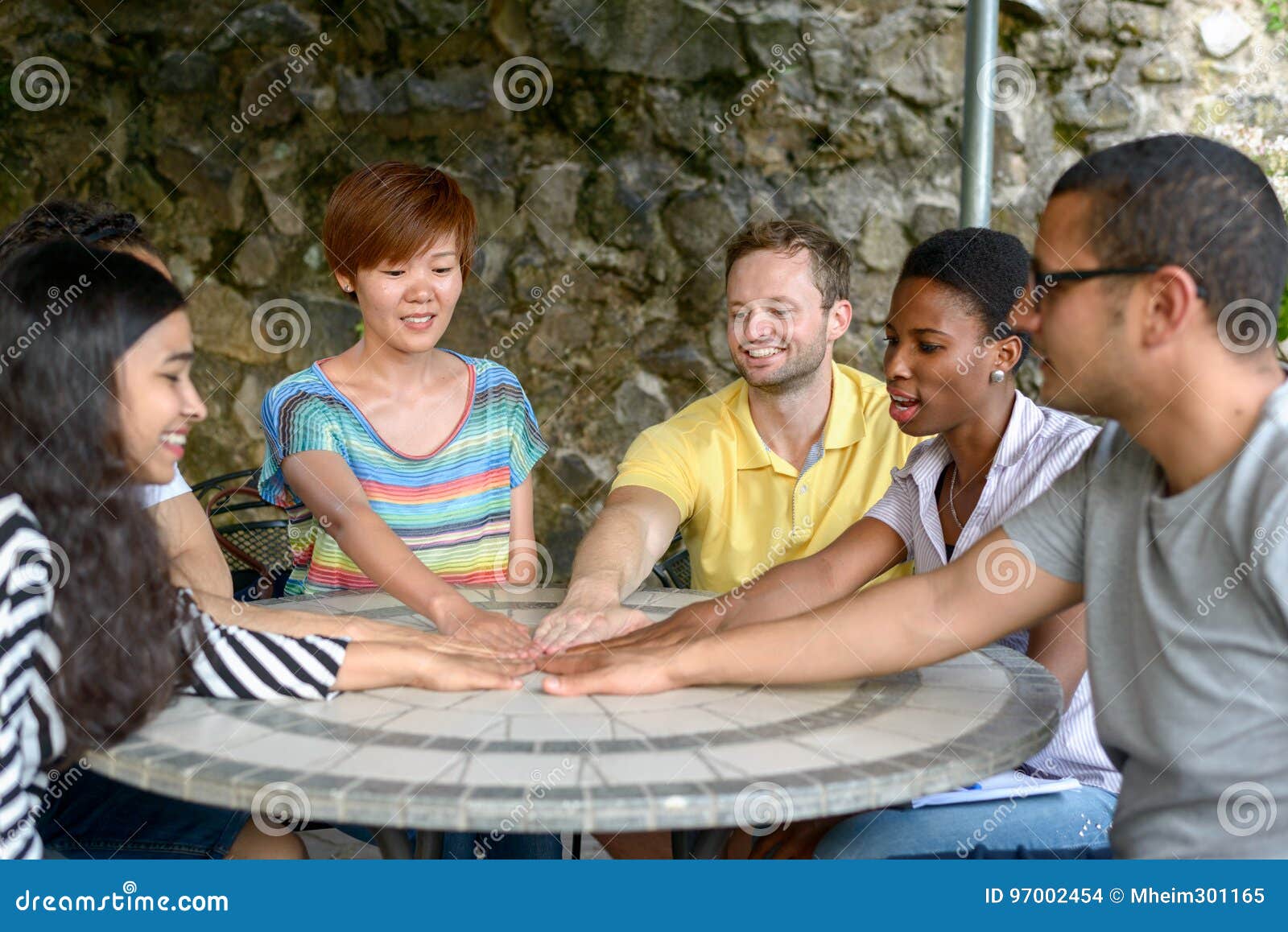 Group of Students Putting Hands on Table Stock Photo - Image of table ...