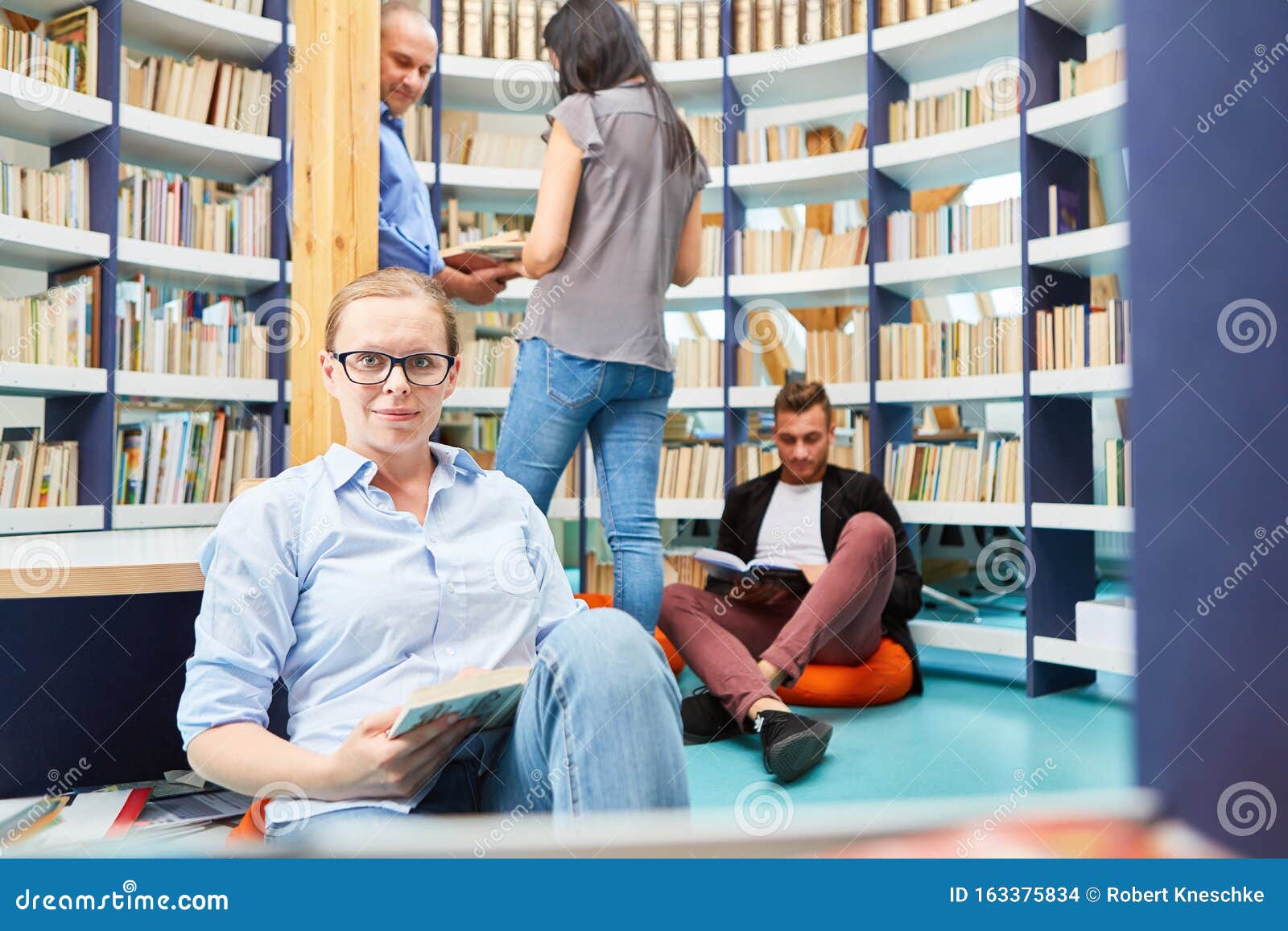 Group of Students Reading the Book in the Library Stock Photo - Image ...