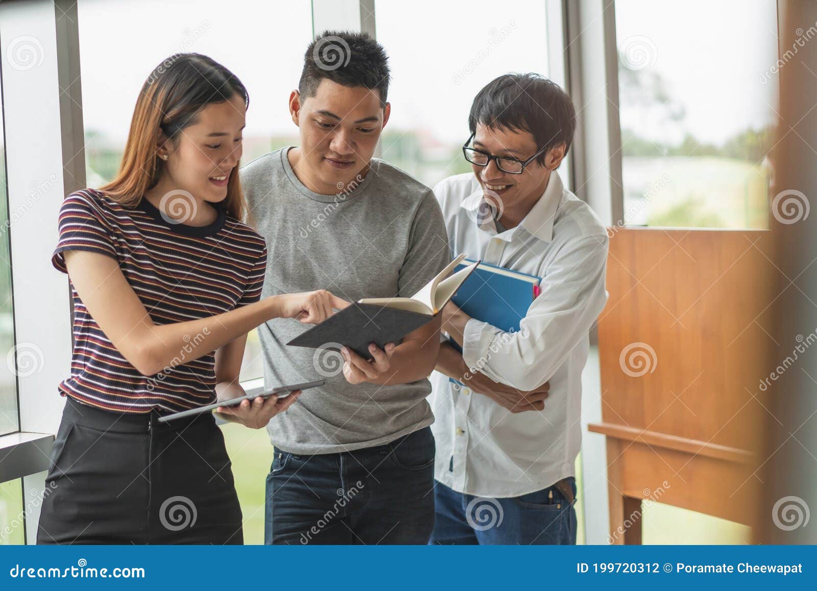 Group of Students Researching Data for Homework Assignment in Library ...