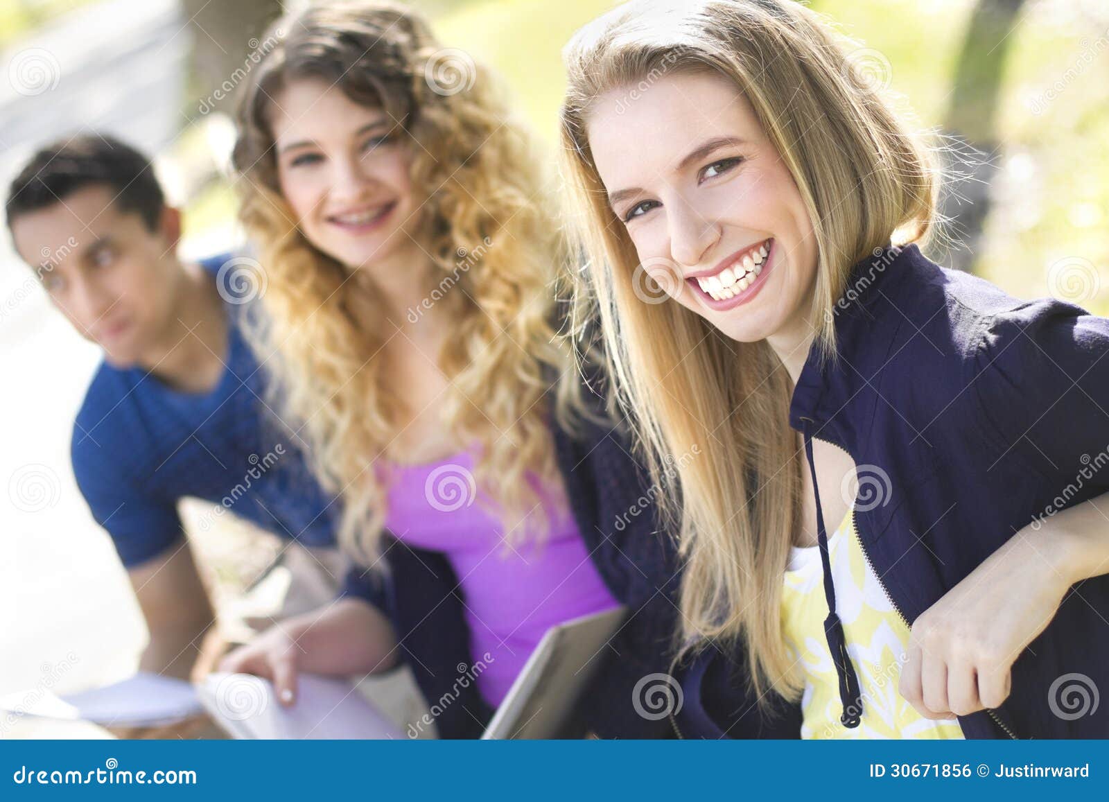 Group of Students Sitting on a Bench Stock Photo - Image of young ...