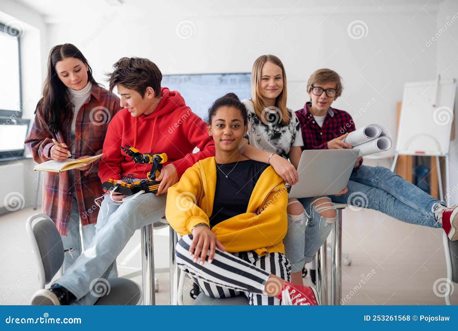 Group of Students Sitting and Posing Together in Robotics Classroom ...