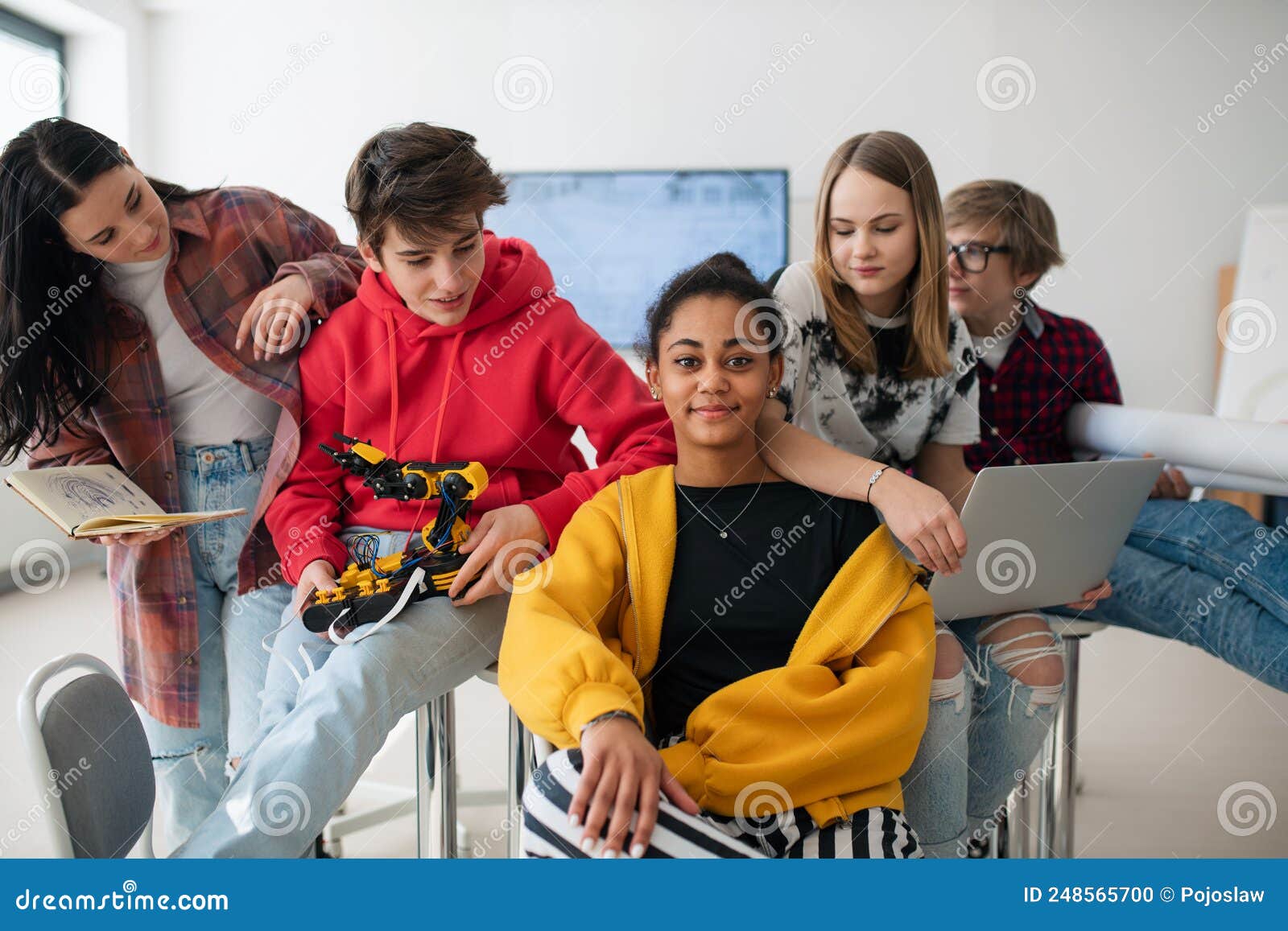 Group of Students Sitting and Posing Together in Robotics Classroom ...