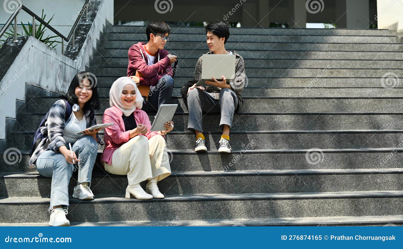 Group of Students Talking To Each Other after Classes while Sitting in ...
