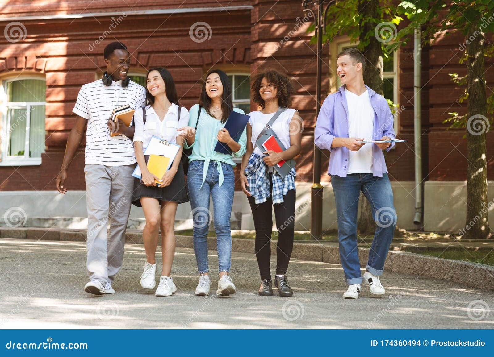 Group of Students Walking Outdoors in University Campus Together Stock ...