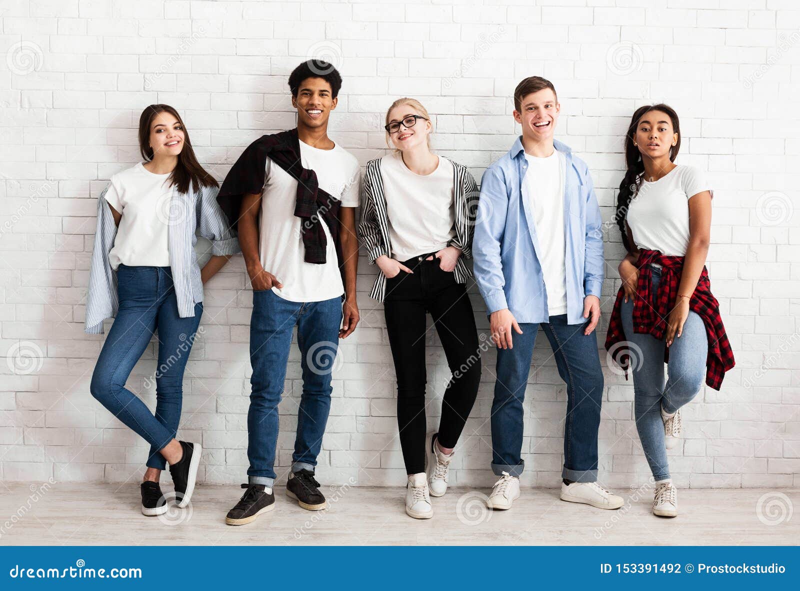 Group of Stylish Friends Students Posing Over White Wall Stock Photo ...