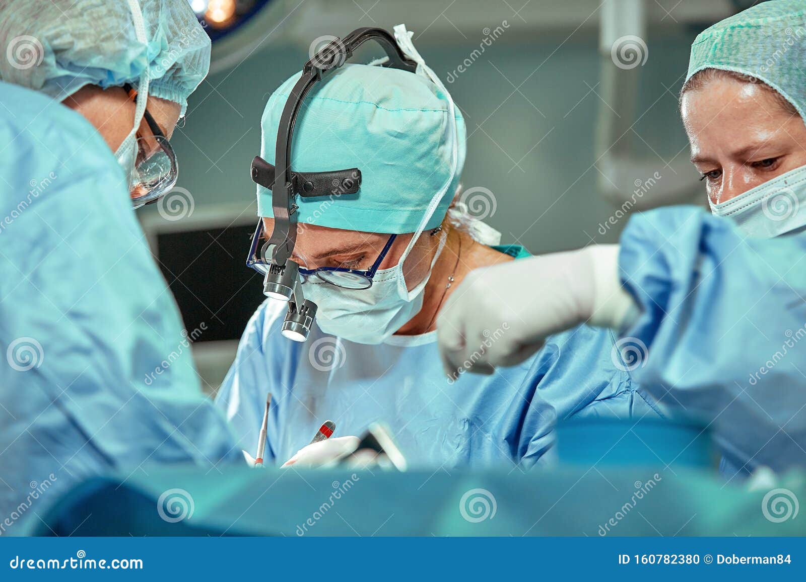 Group of Surgeons Looking at Patient on Operation Table during Their ...