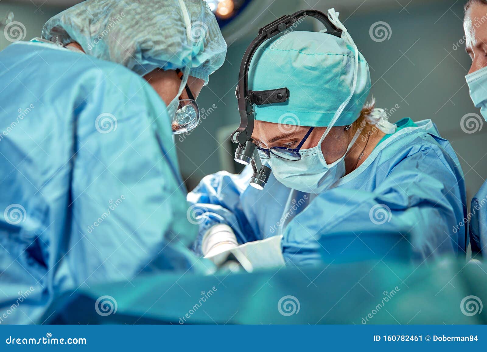 Group of Surgeons Looking at Patient on Operation Table during Their ...