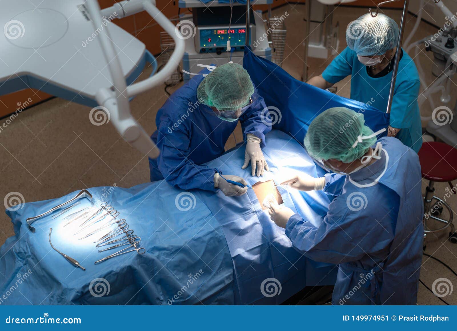 Group of Surgeons at Work in Operating Theater. Medical Team Performing ...