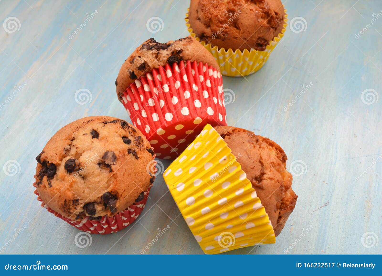 Group of Tasty Colored Muffins Placed on Wooden Blue Table Stock Image ...
