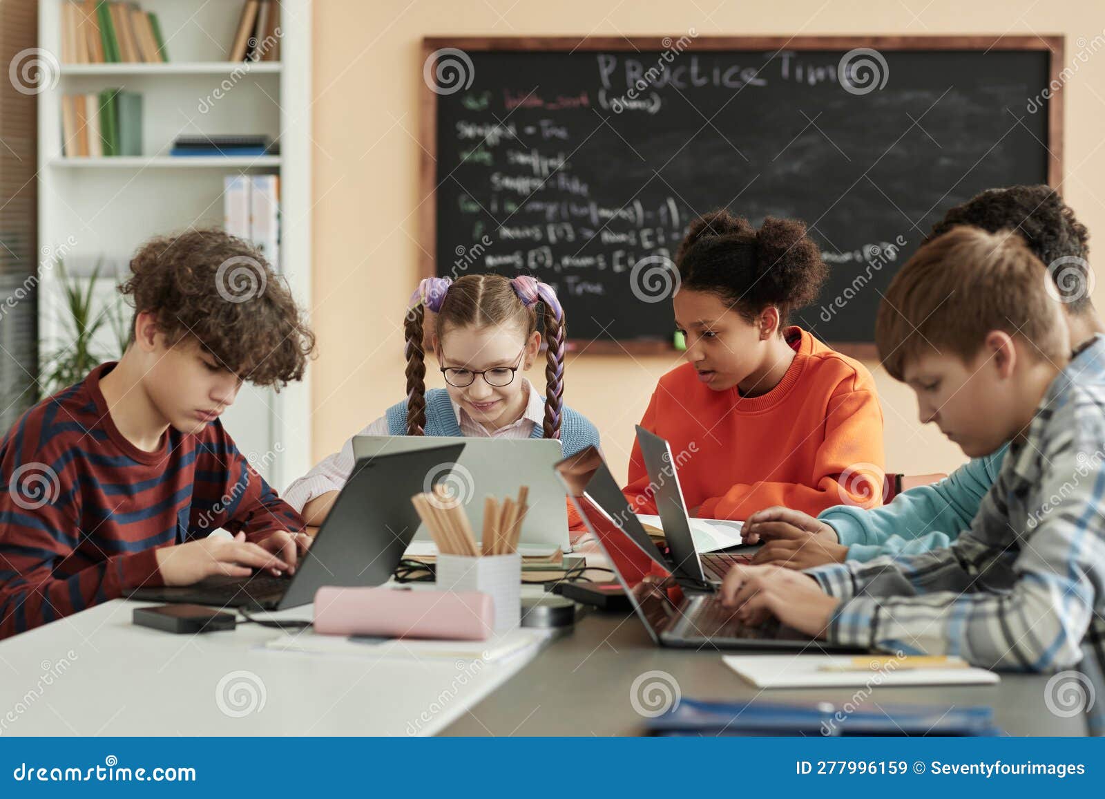 Group of Teen Children Using Laptops in School Classroom Studying Stock ...