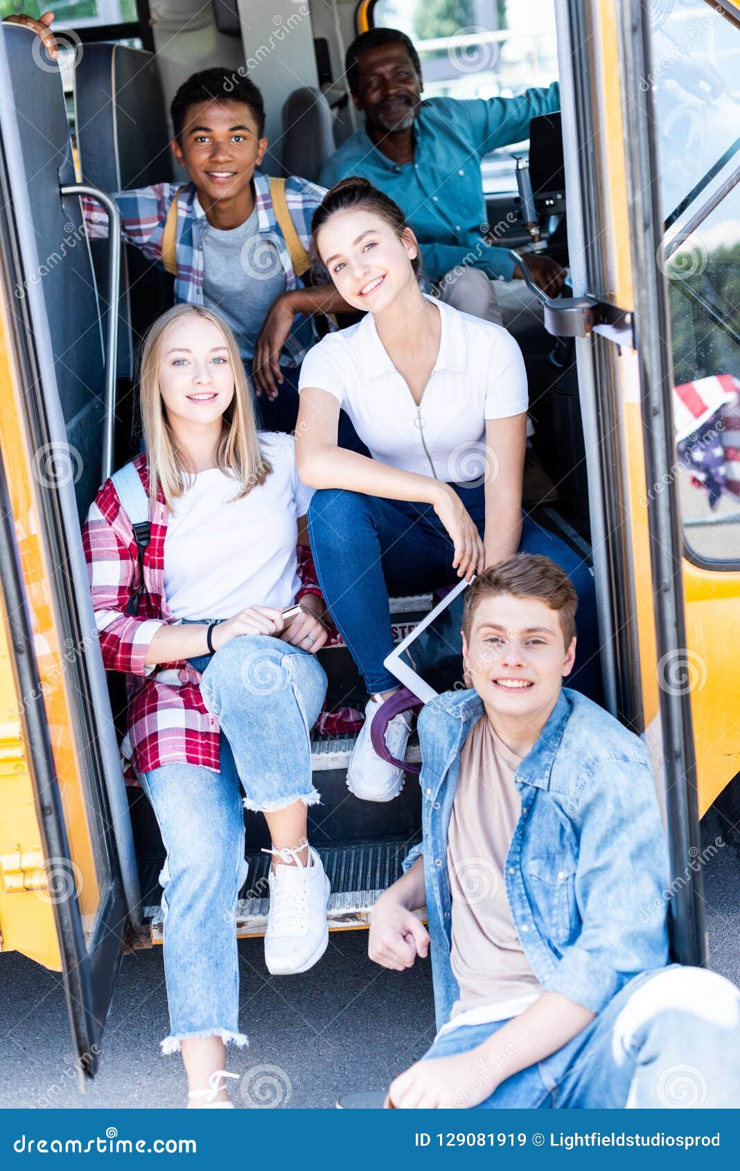 Group of Teen Scholars Sitting at School Bus with Driver Inside and ...