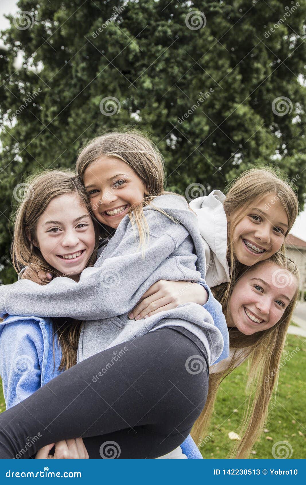 Group of Teenage Girls Playing and Smiling Together Outdoors Stock ... Group of Teenage Girls Playing and Smiling Together Outdoors Stock ...
