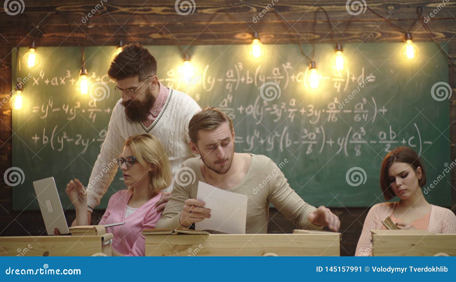 Group of Teenage Students Collaborating on Project in Classroom. Group ...