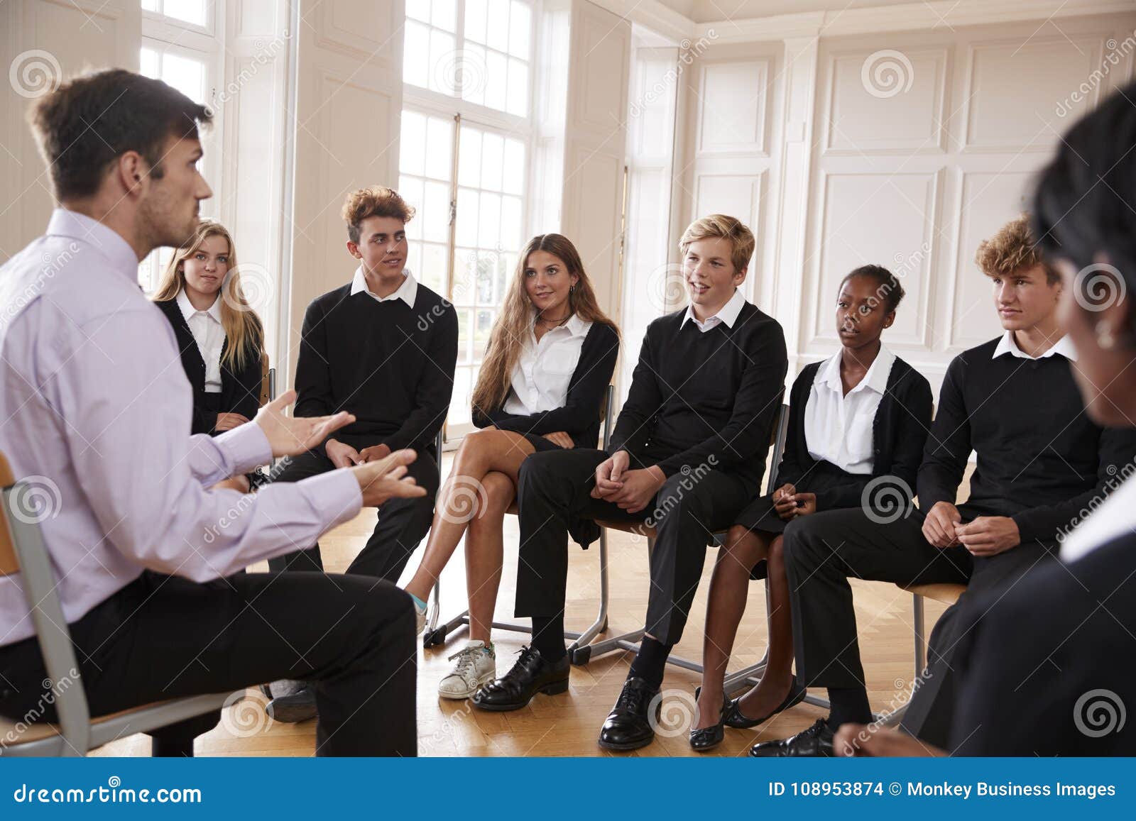 Group of Teenage Students Having Discussion with Tutor Stock Photo ...
