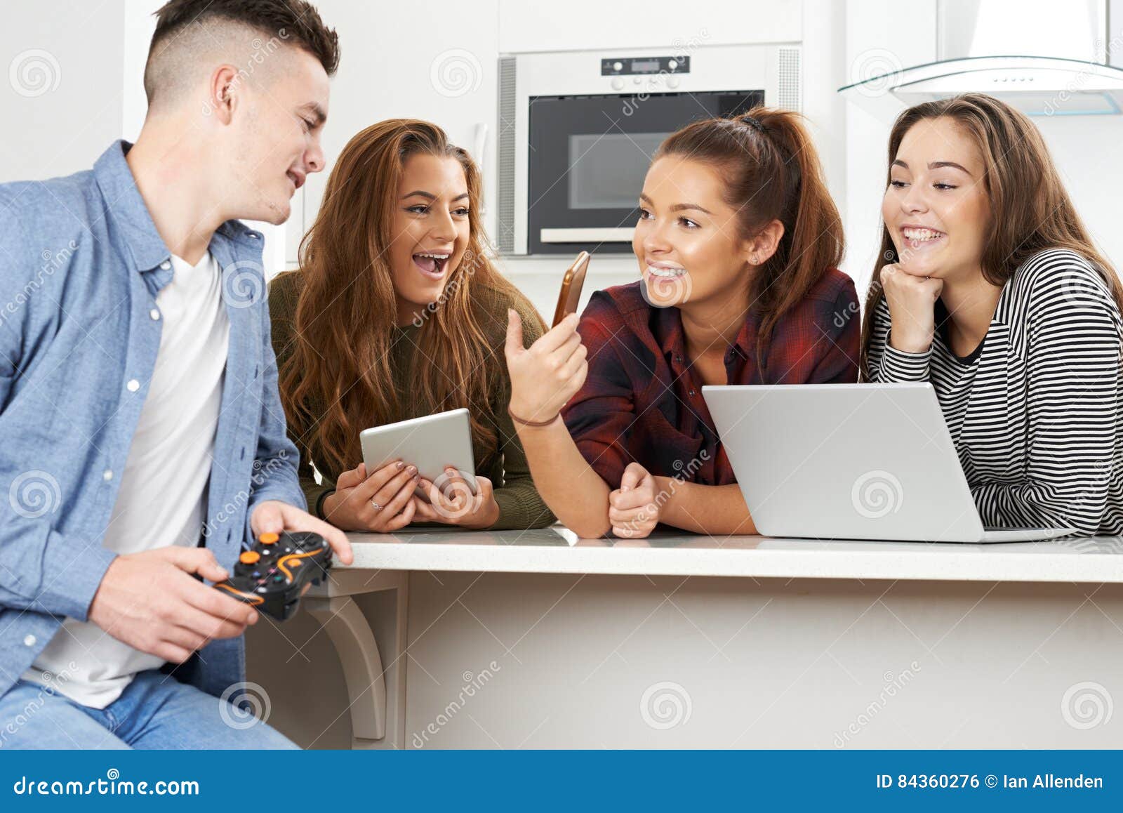 Group of Teenagers Using Digital Technology at Home Stock Photo - Image ...