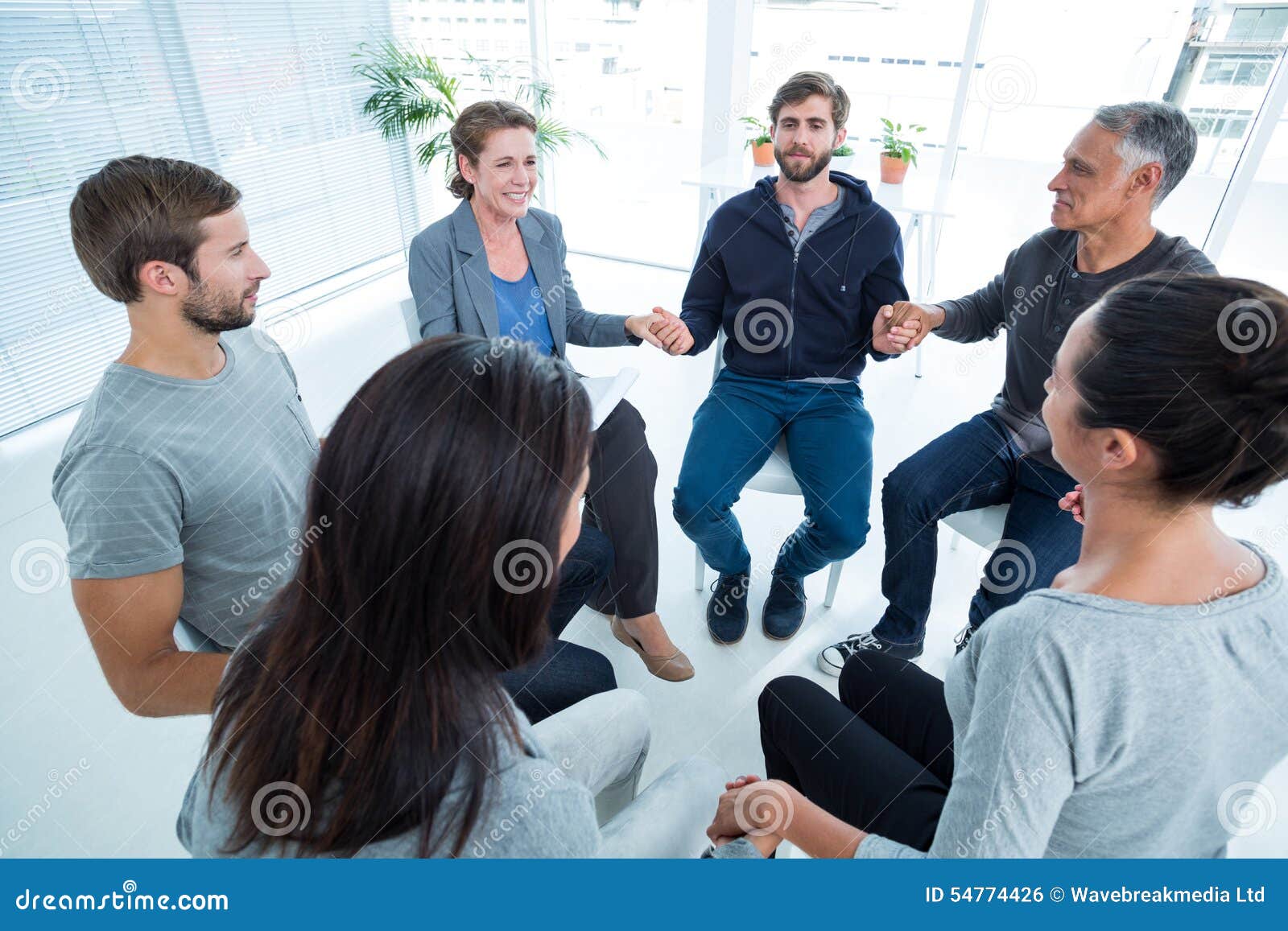 Group Therapy in Session Sitting in a Circle Stock Photo - Image of ...