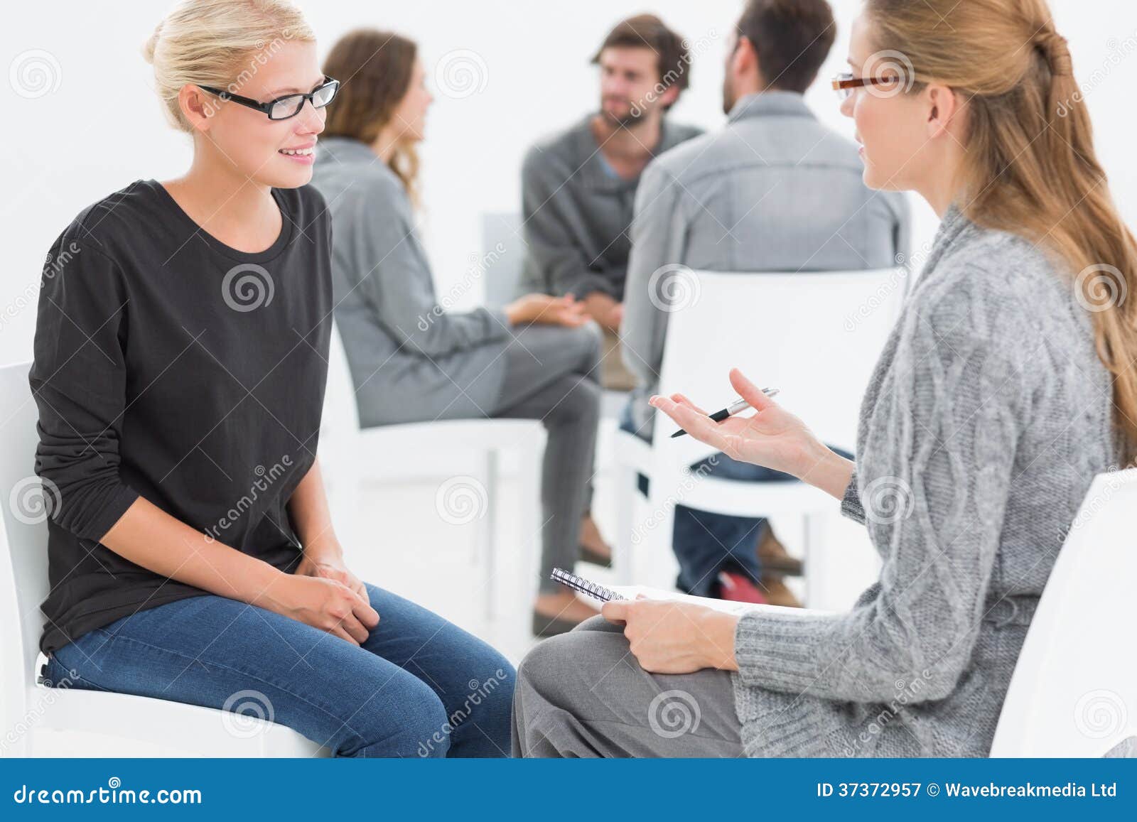 Group Therapy Session with Therapist and Client in Foreground Stock ...