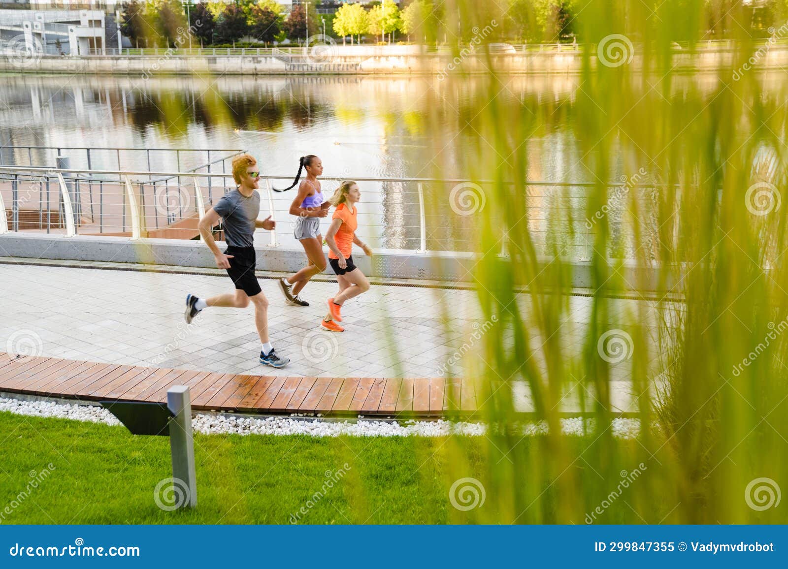 Group of Three Active People Running Together Outdoors on Bridge Stock Image - Image of friends ...