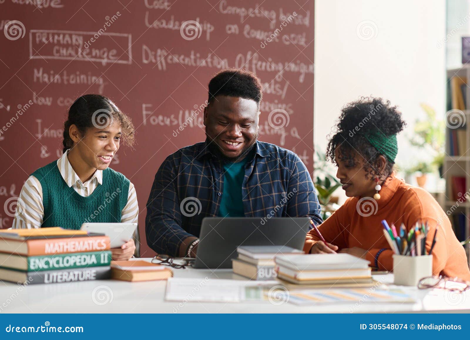 Group of Three Black People in College Class Looking at Laptop Stock ...
