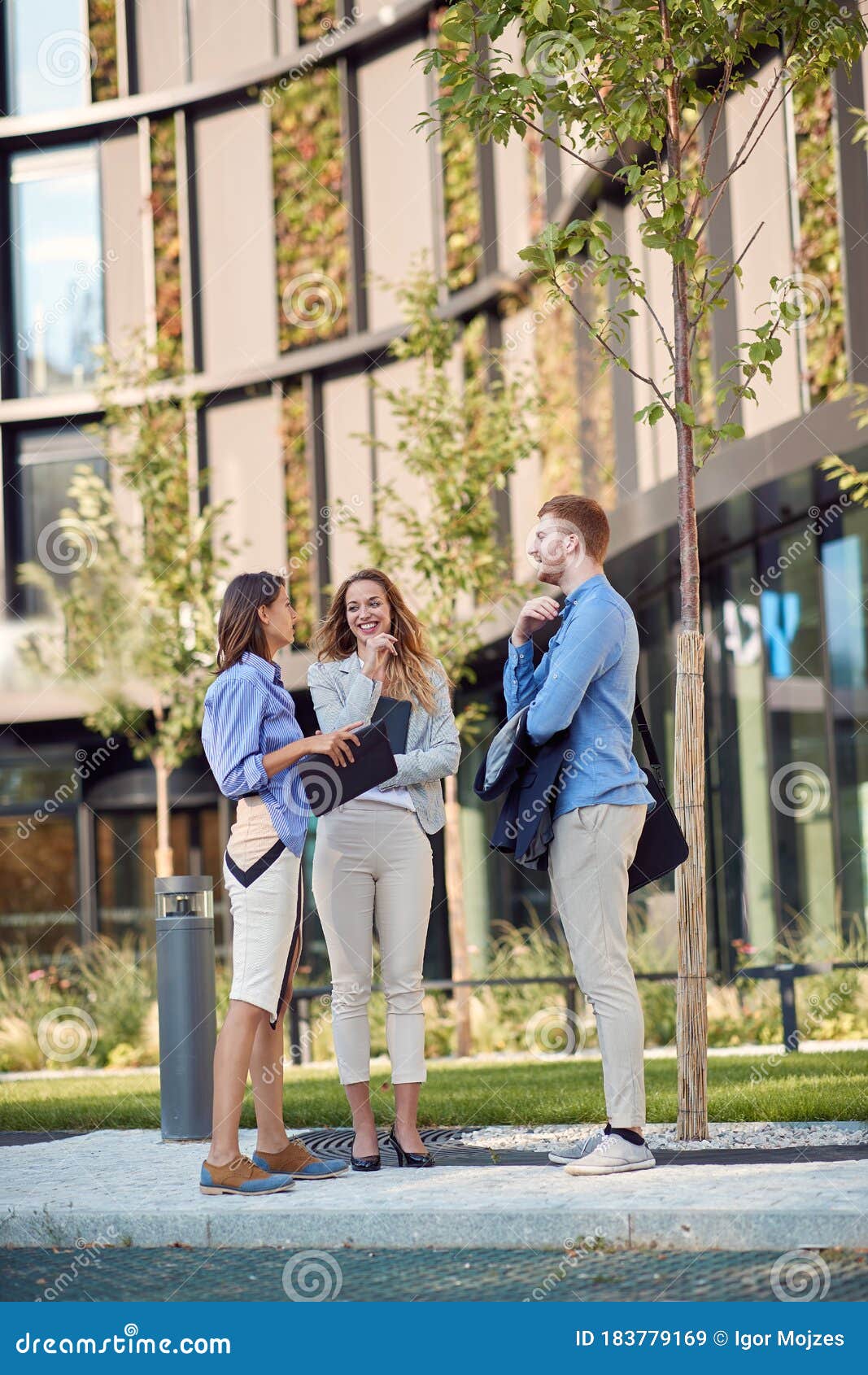 Group of Three Caucasian Business People Talking in Front of a Building ...