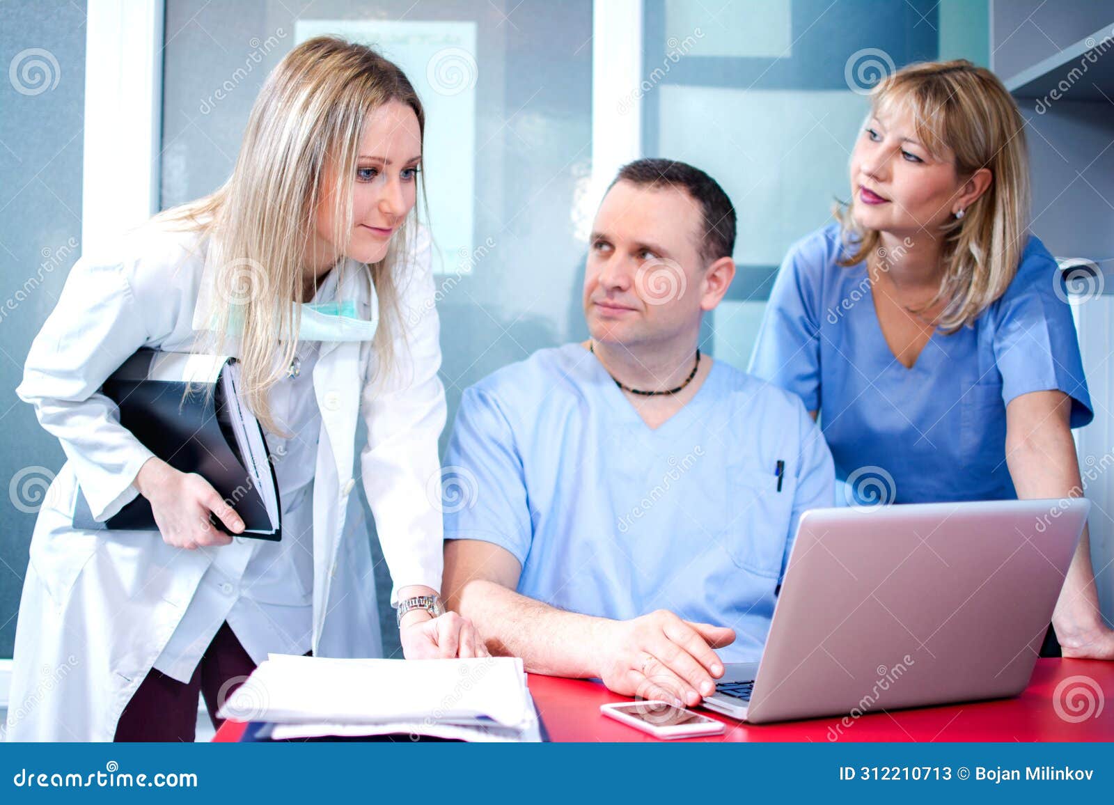 Group of Three Doctors Working Together on a Laptop in Doctor S Office ...
