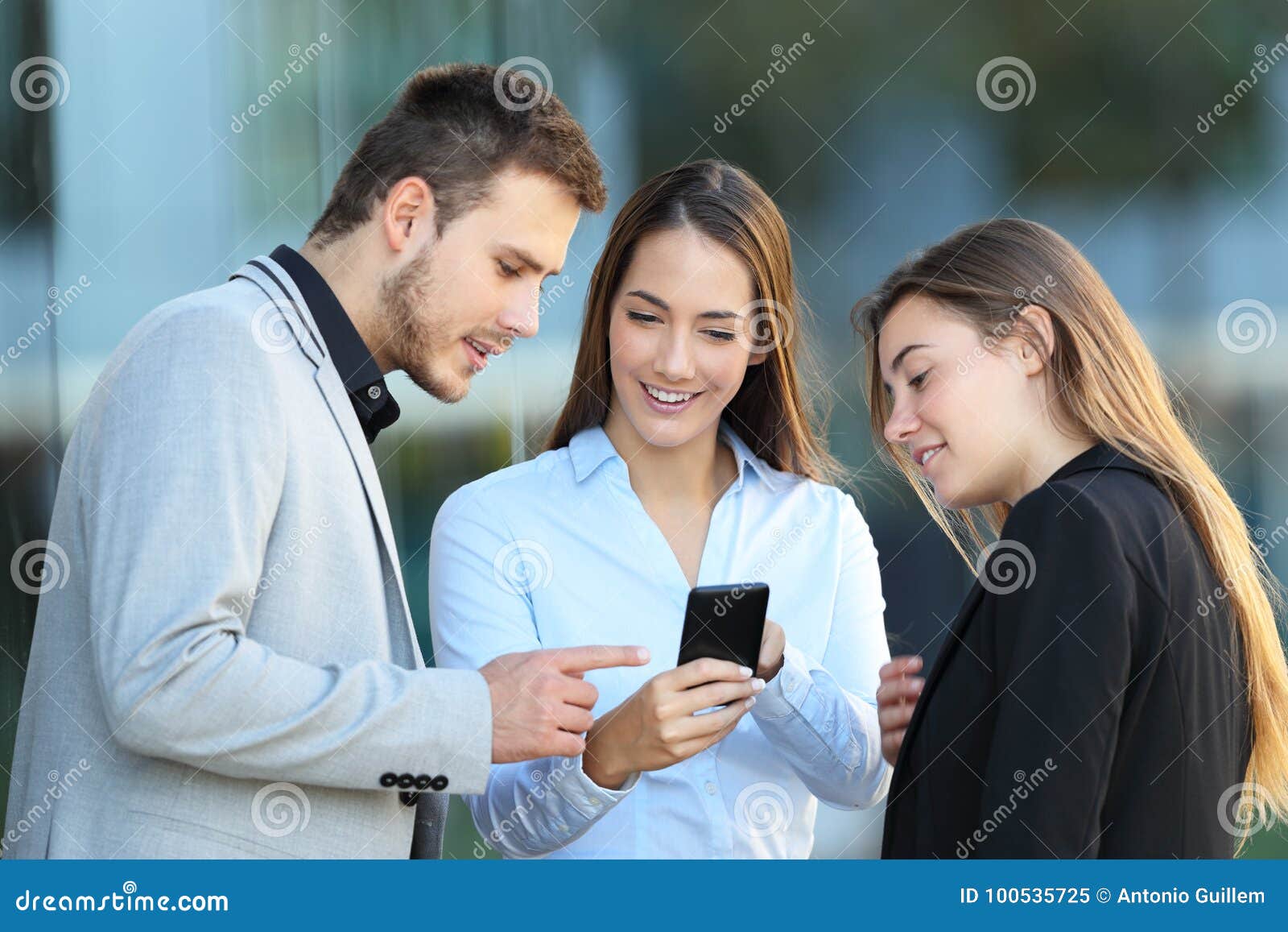 Group of Executives Using a Phone on the Street Stock Image - Image of ...