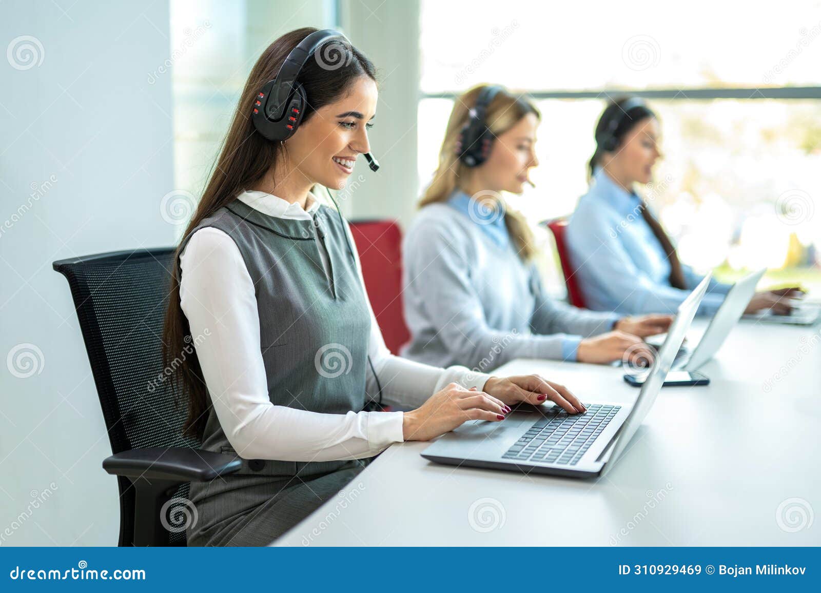 Group of Three Female Customer Support Operators Sitting in Row and ...