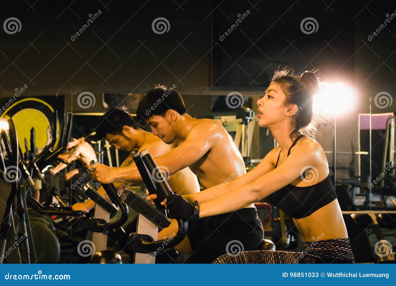 Group of Three People Biking at Indoors the Gym with Exercising Stock ...