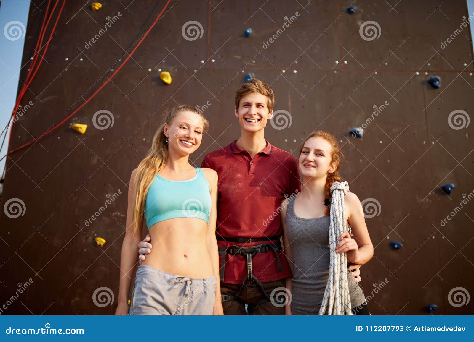 Group of Three Rock Climbers with Safety Equipment Smiling and Looking ...