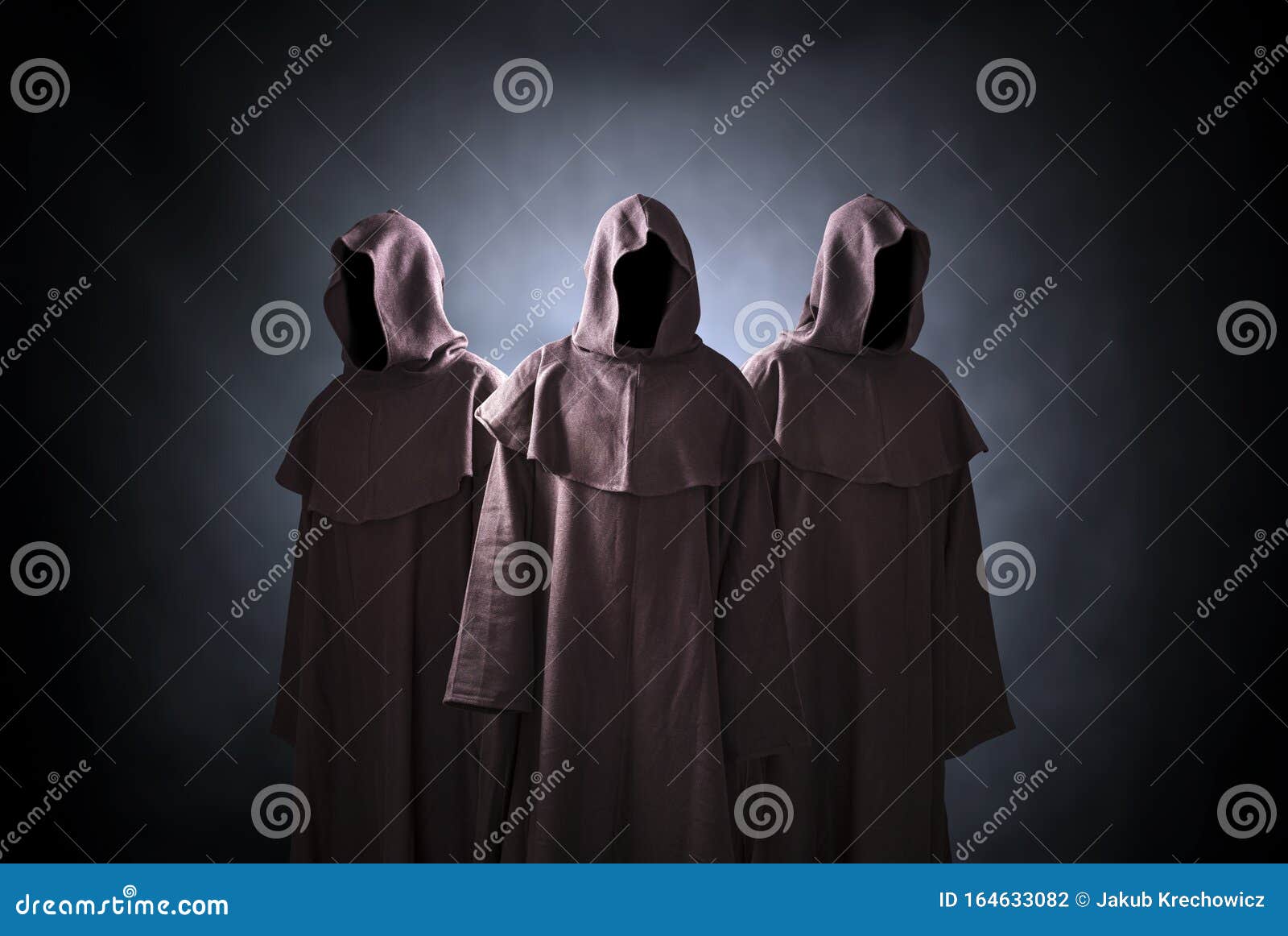 Group of Three Scary Figures in Hooded Cloaks Stock Photo - Image of ...