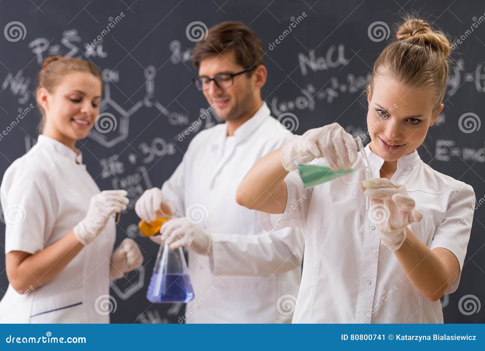 Group of Three Students Conducting an Experiment Stock Image - Image of ...