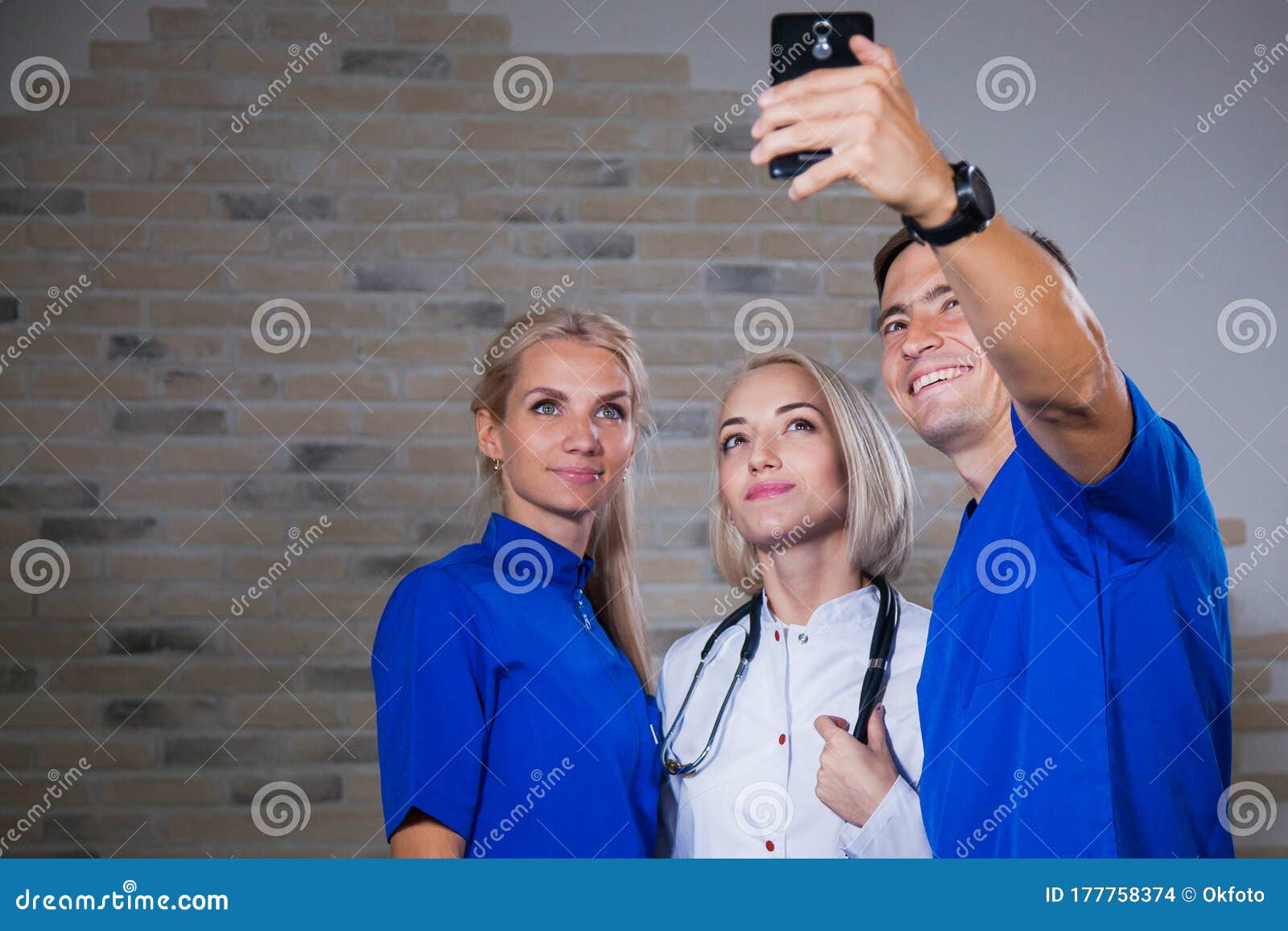 Group of Three Young Doctors Making Selfie in White and Blue Uniform ...