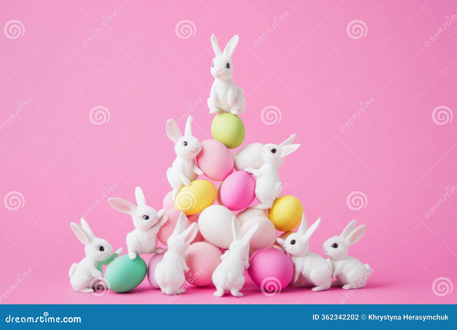 A Group of Tiny Easter Bunnies Stacking Easter Eggs into a Giant ...