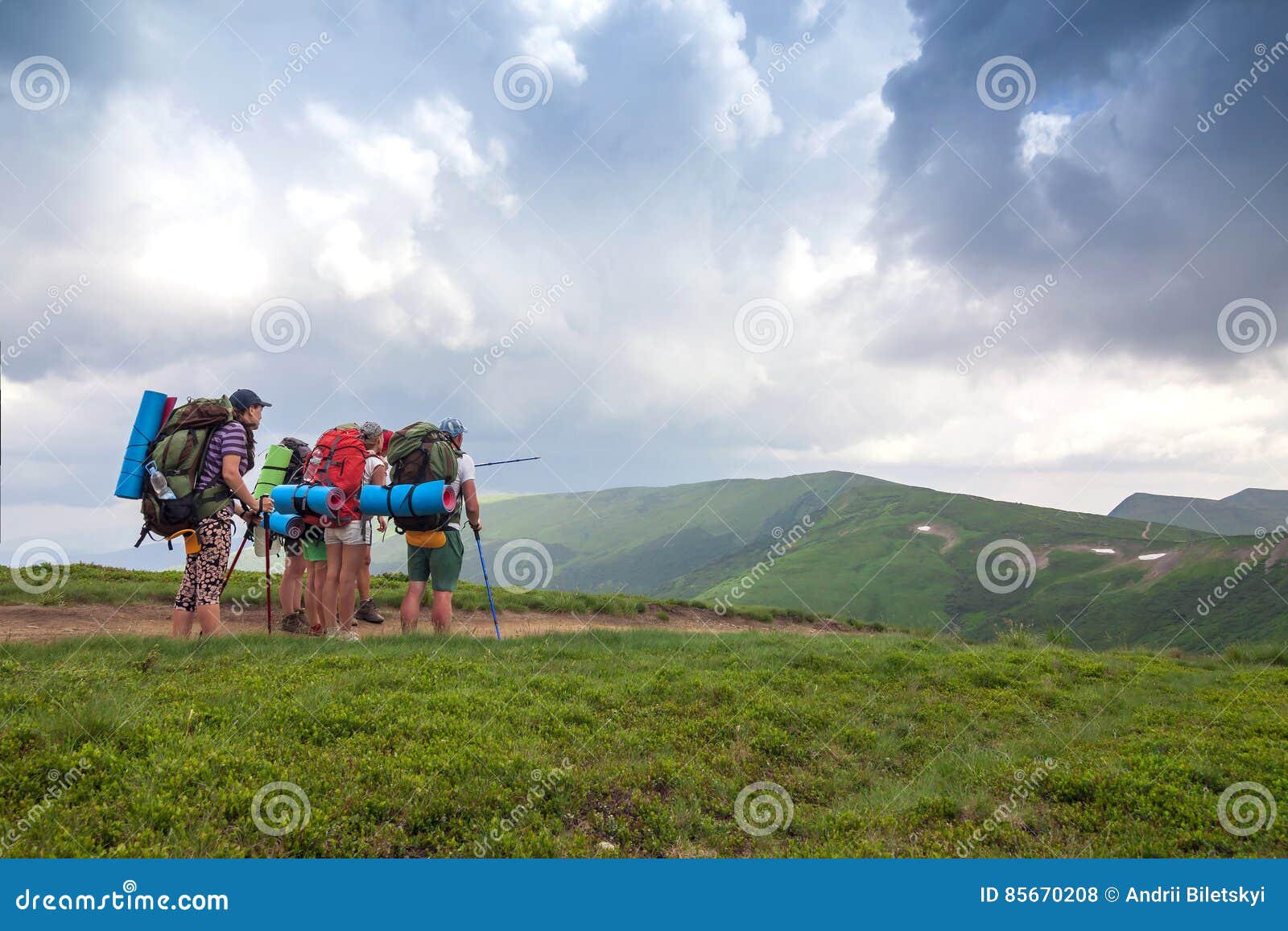 Group of Tourists Hikers with Backpacks Standing in Mountains Stock ...