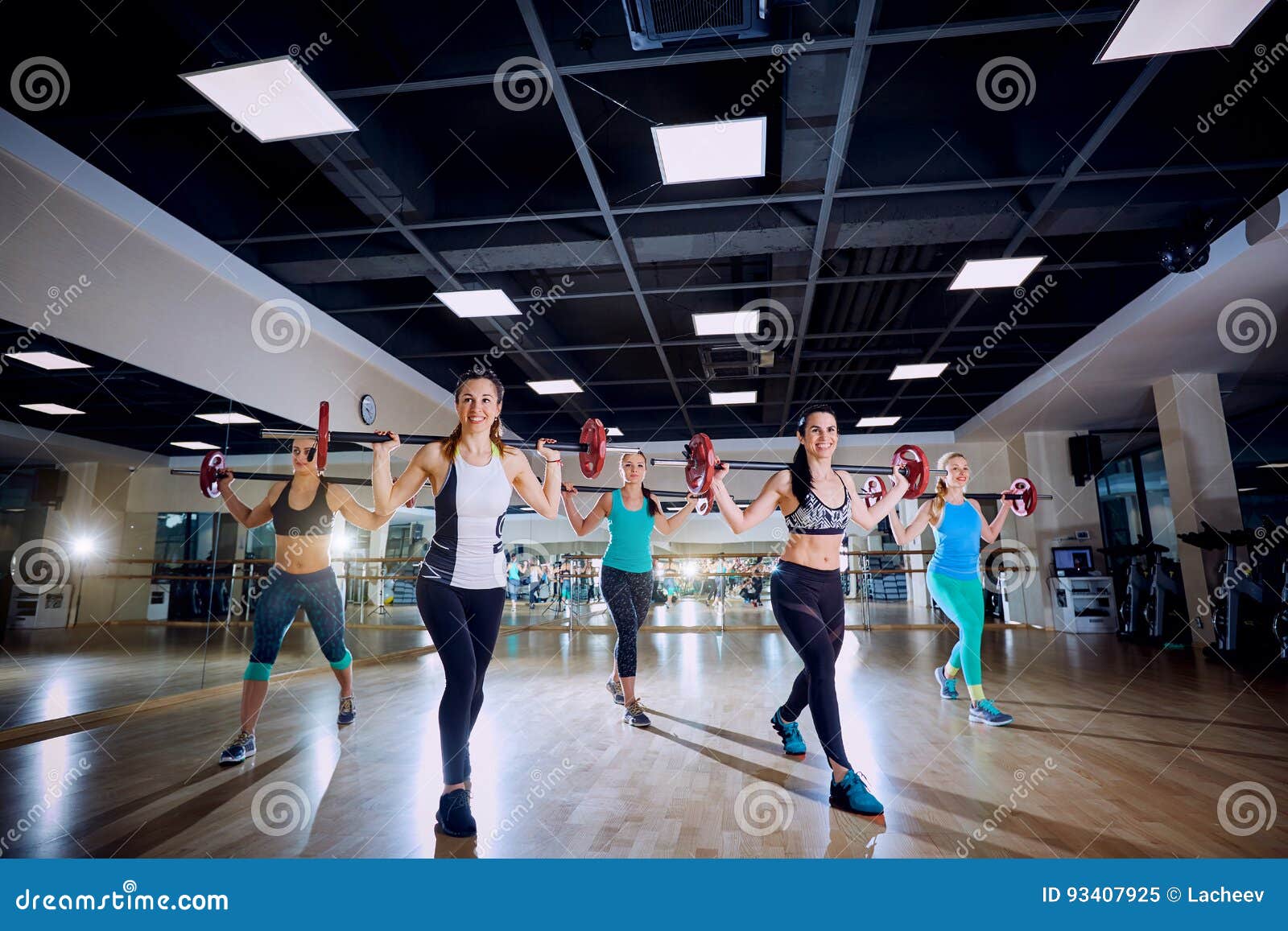 Group Training. Girls Doing Exercises with a Bar in the Gym Stock Image ...