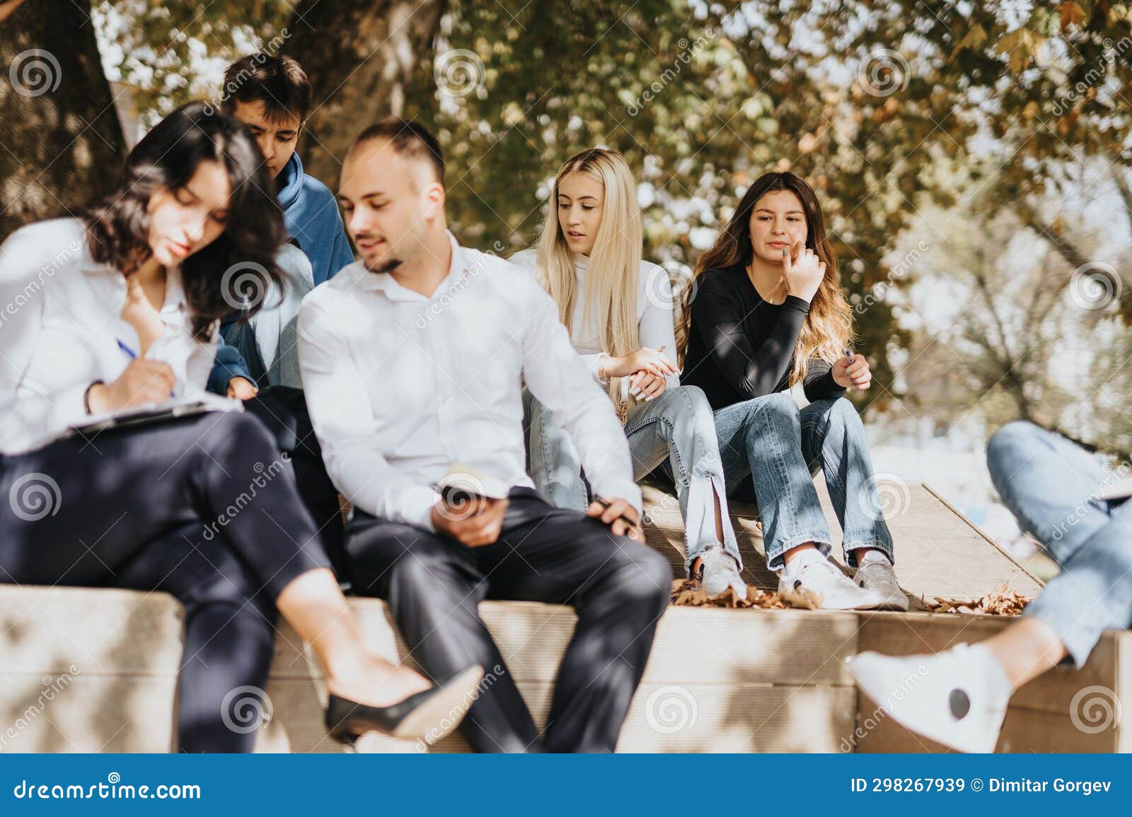 Group of University Students Exchanging Knowledge and Studying Together ...