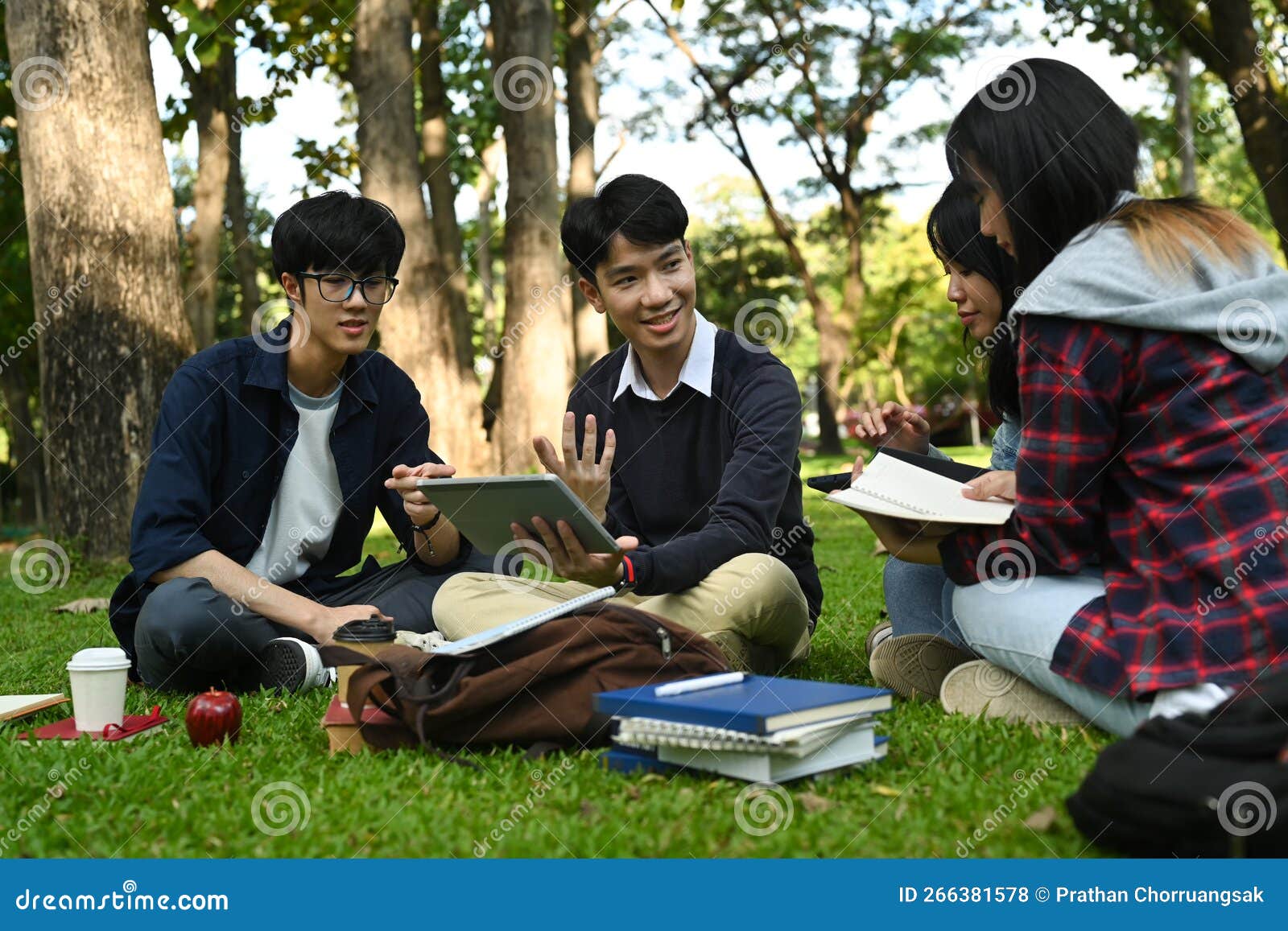Group of University Students Learning Together while Sitting Under the ...