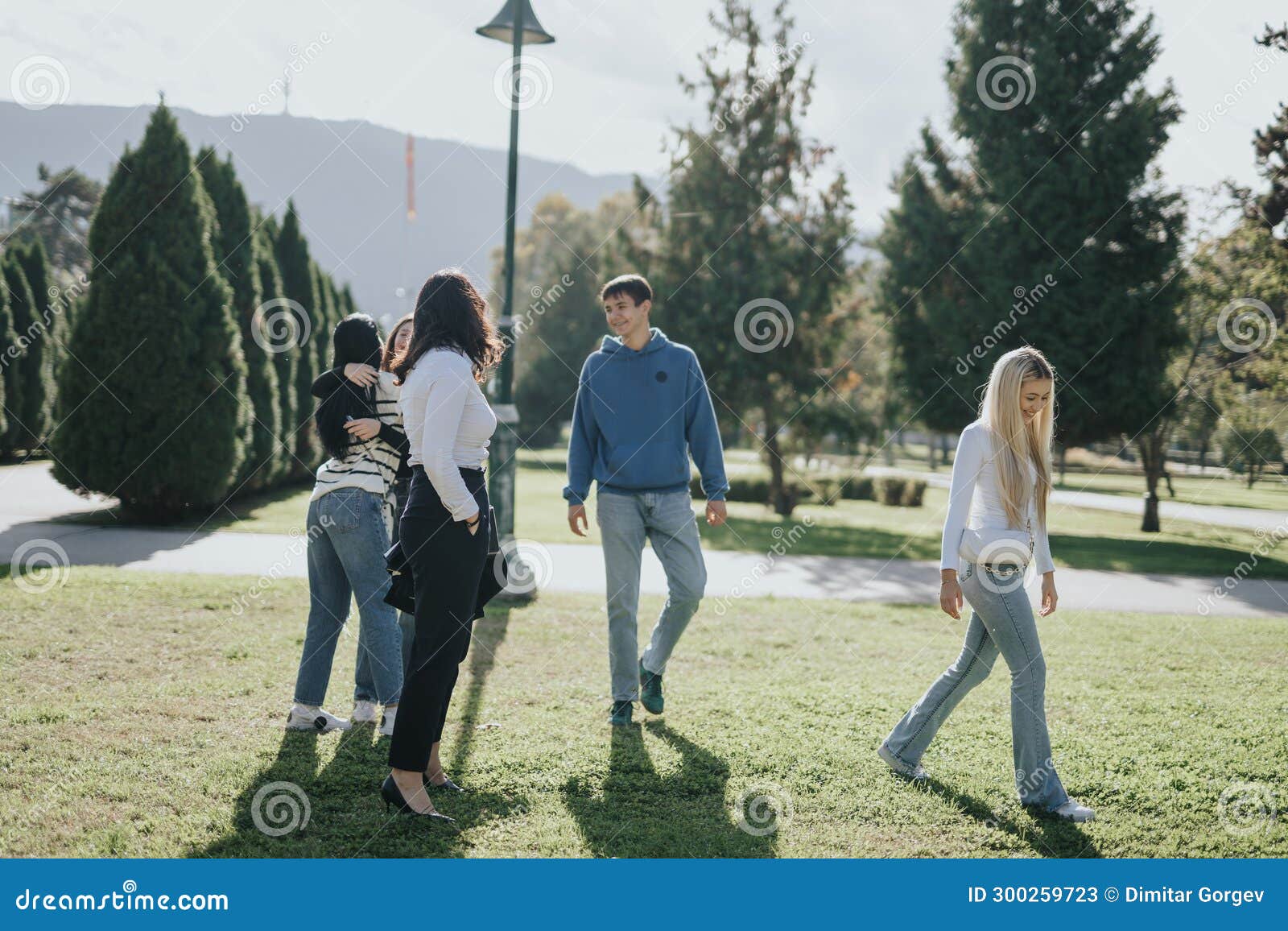Group of University Students Walking in Park, Hanging Out after Classes ...