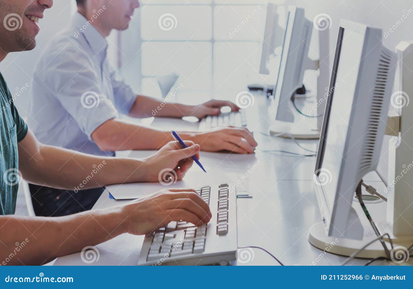 Group of University Students Working on Computers in Campus Classroom ...