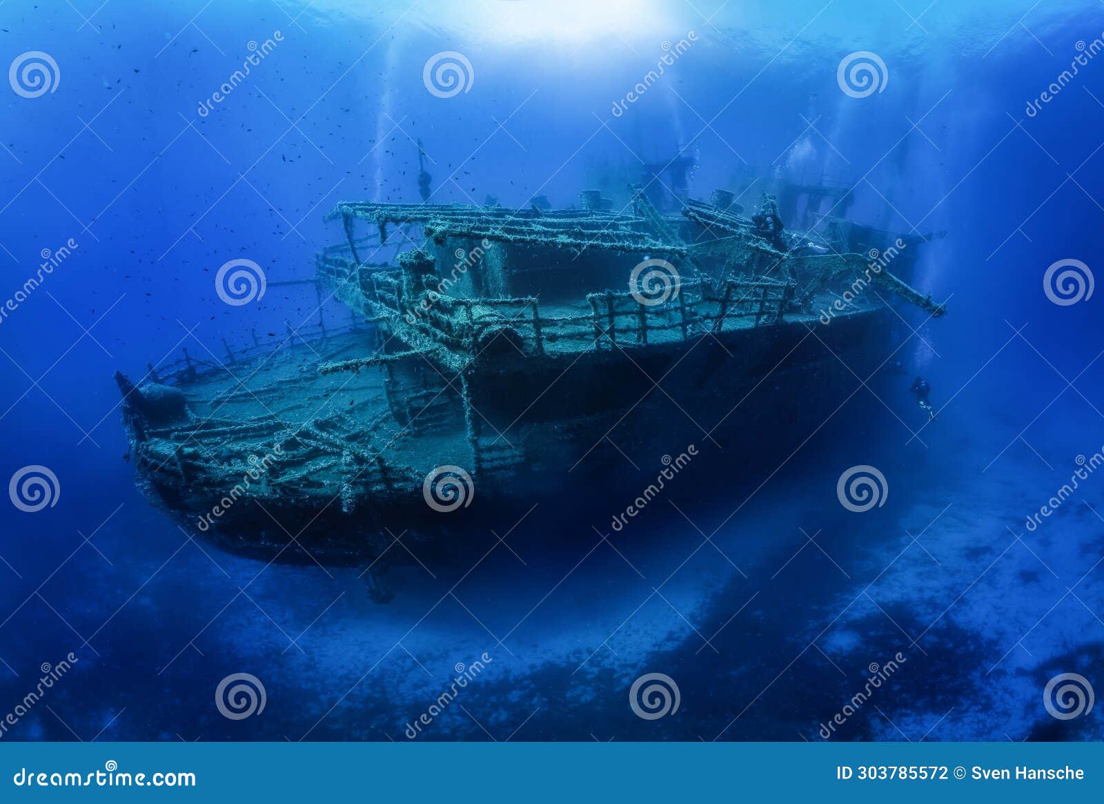 A Group of Unrecognizable Divers Explore a Sunken Shipwreck Stock Photo ... A Group of Unrecognizable Divers Explore a Sunken Shipwreck Stock Photo ...
