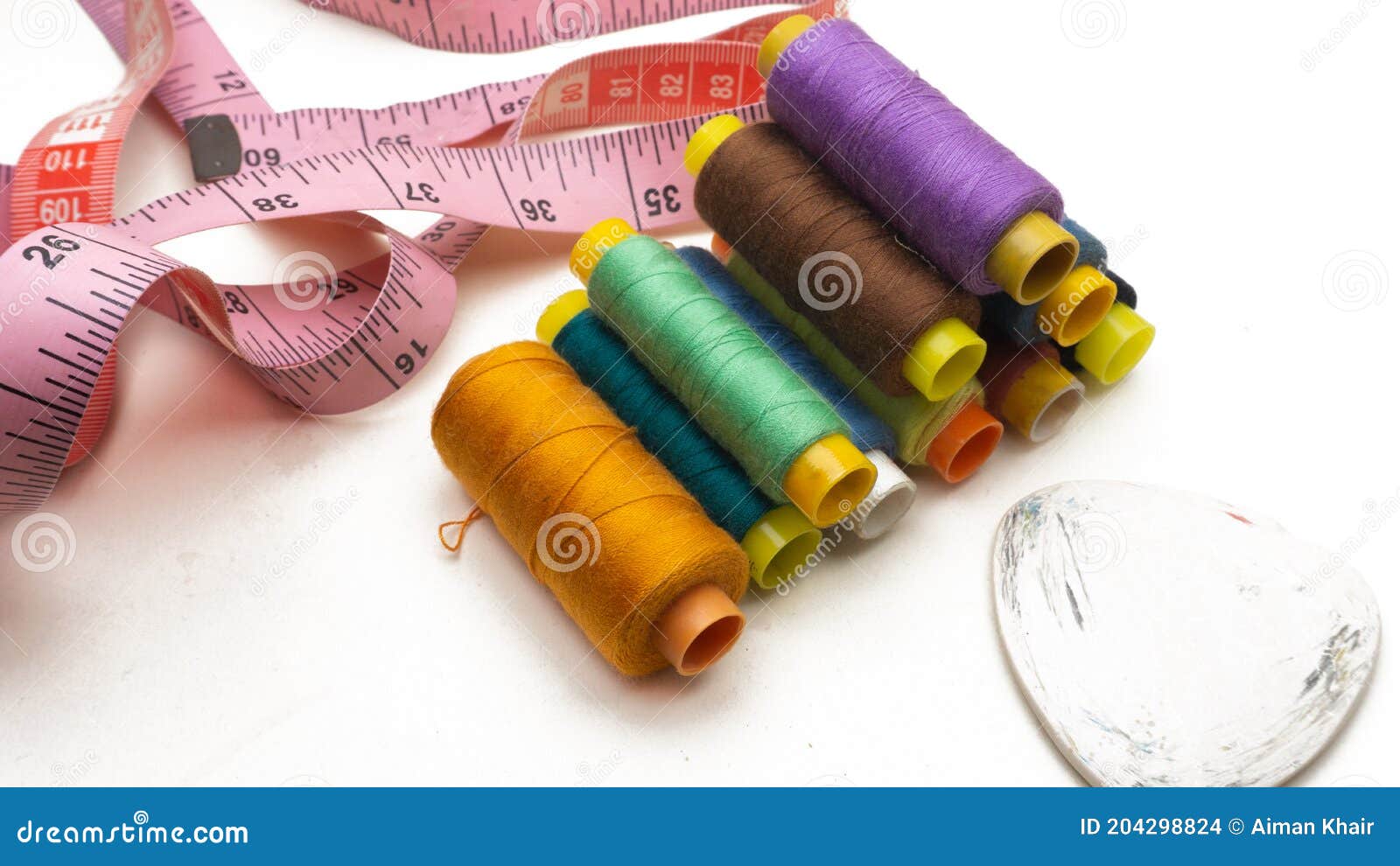 Sewing Thread Roll, Fabric Marker Chalk and Sewing Measuring Tape on an ...