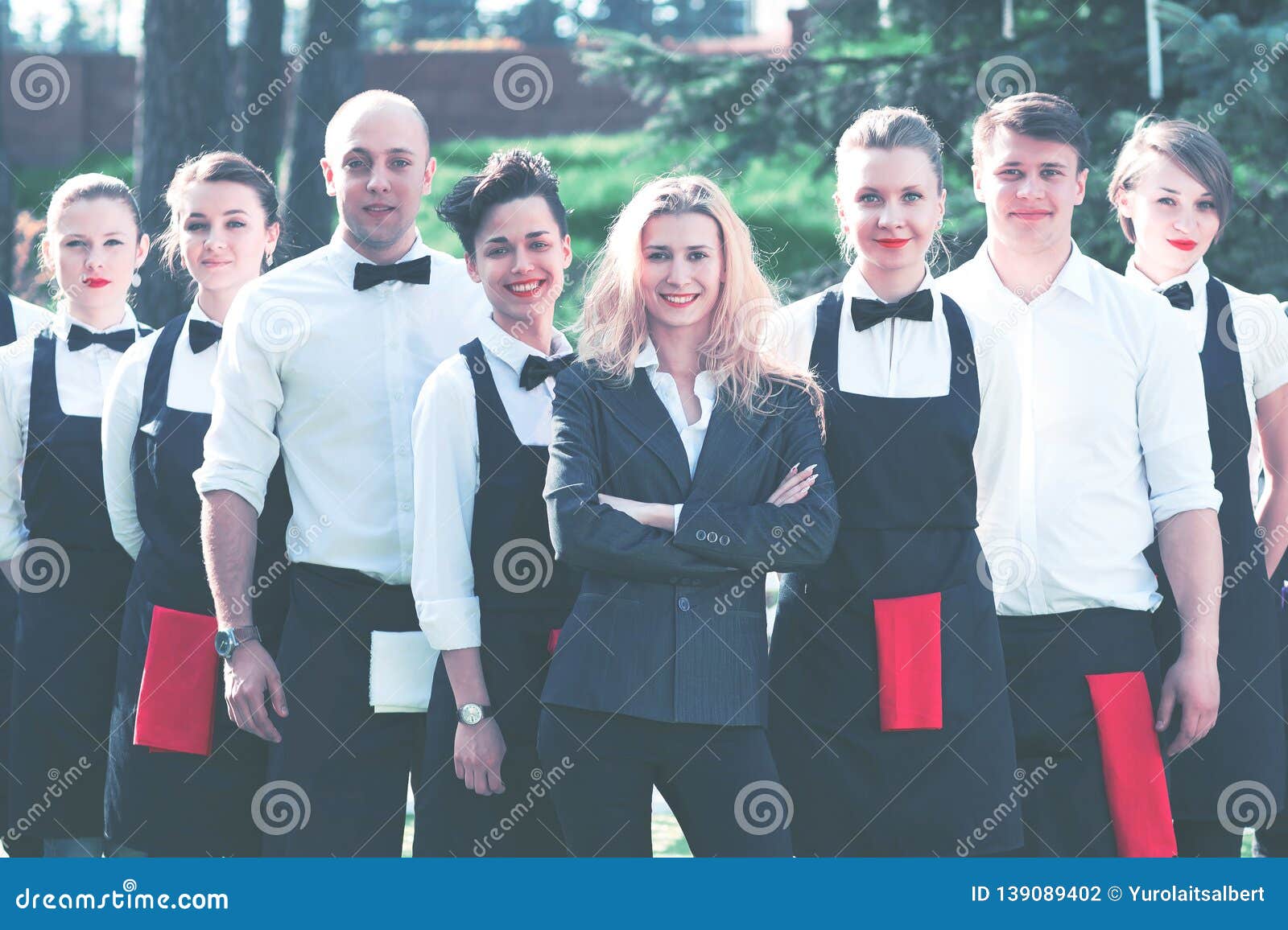 Group of Waiters in the Branded Clothes are on the Lawn in Front Stock ...