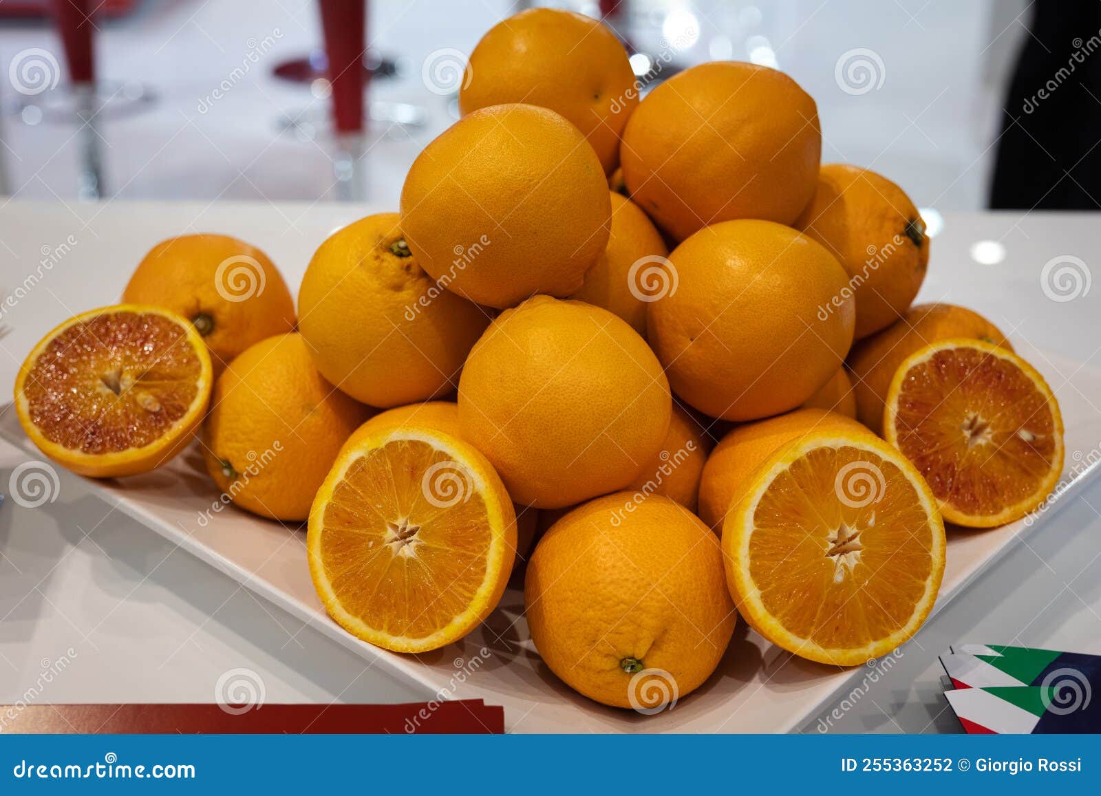 Group of Whole Oranges and Some Oranges Cut in Half Inside a White ...