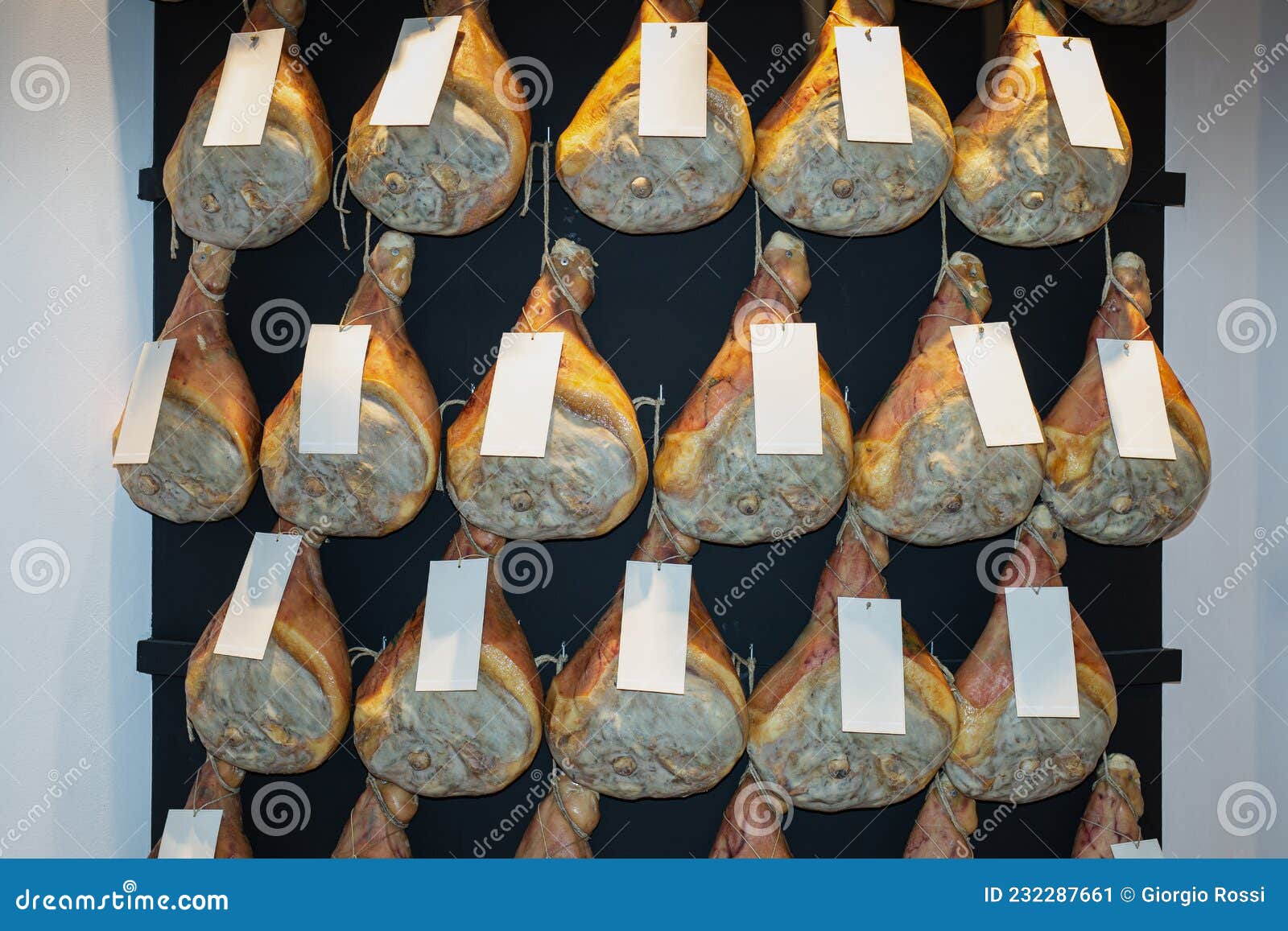 Group of Whole Raw Hams Hung on a Wall Stock Image - Image of holder ...